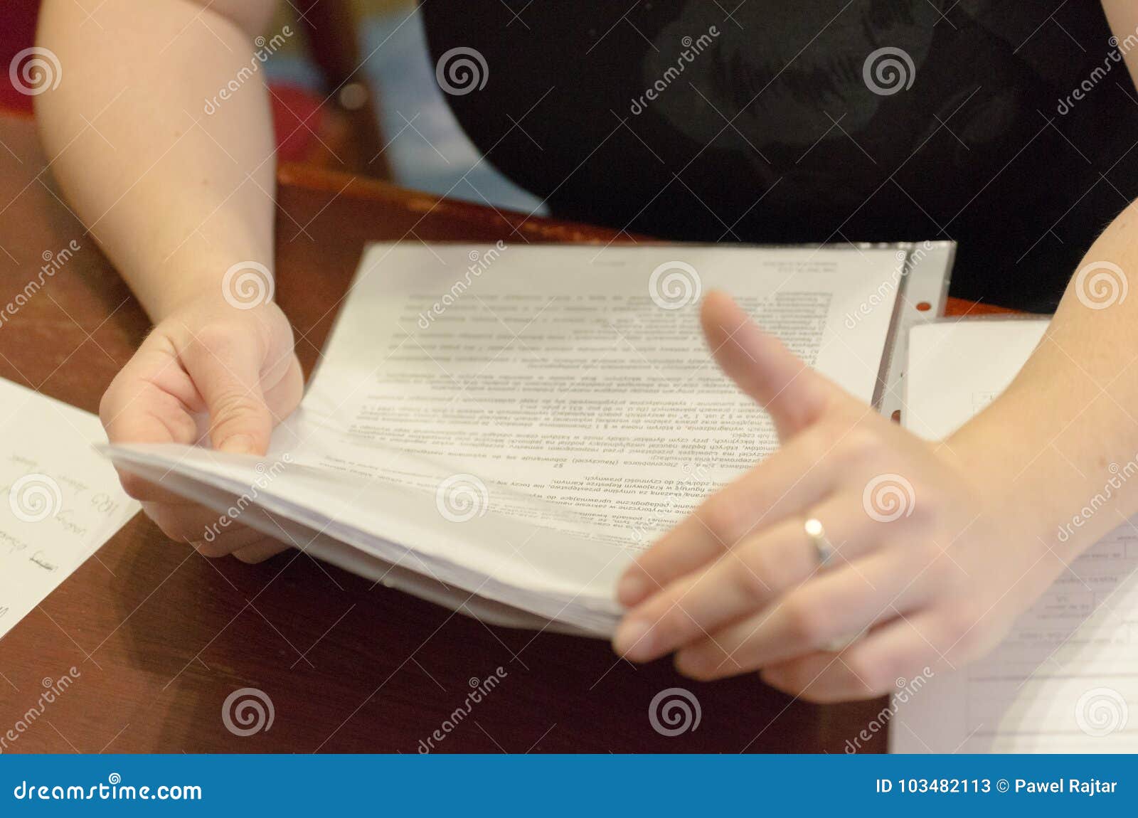 A Person Viewing the Documents on the Table in the Living Room, You Can ...