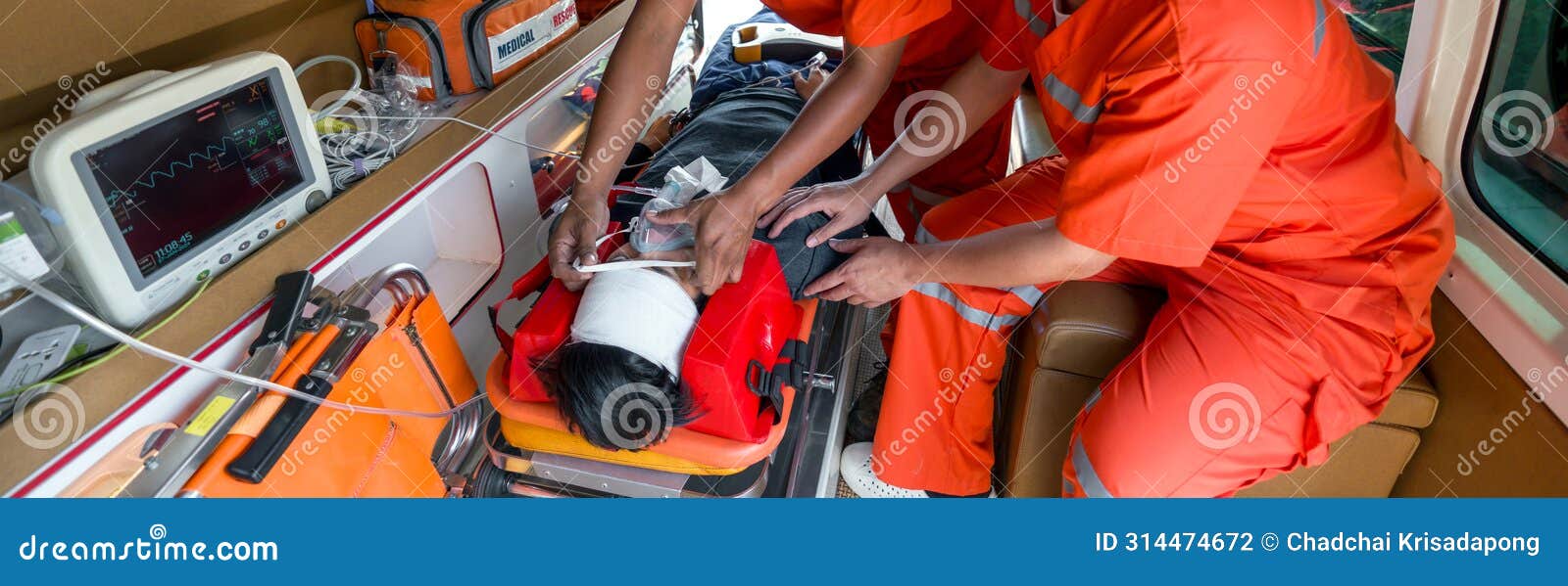 A Person is Wearing an Oxygen Mask, Getting Help from Paramedic in ...