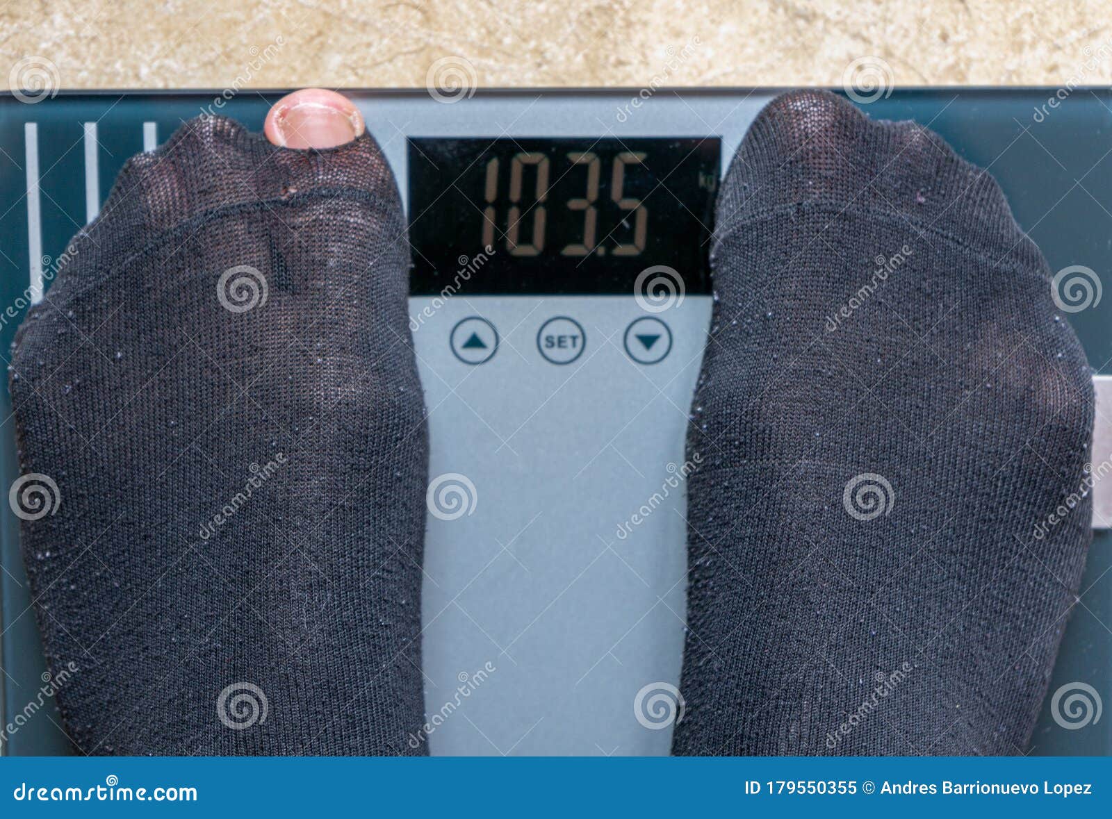 A Man Weighing Himself On A Scale Royalty-Free Stock Image ...