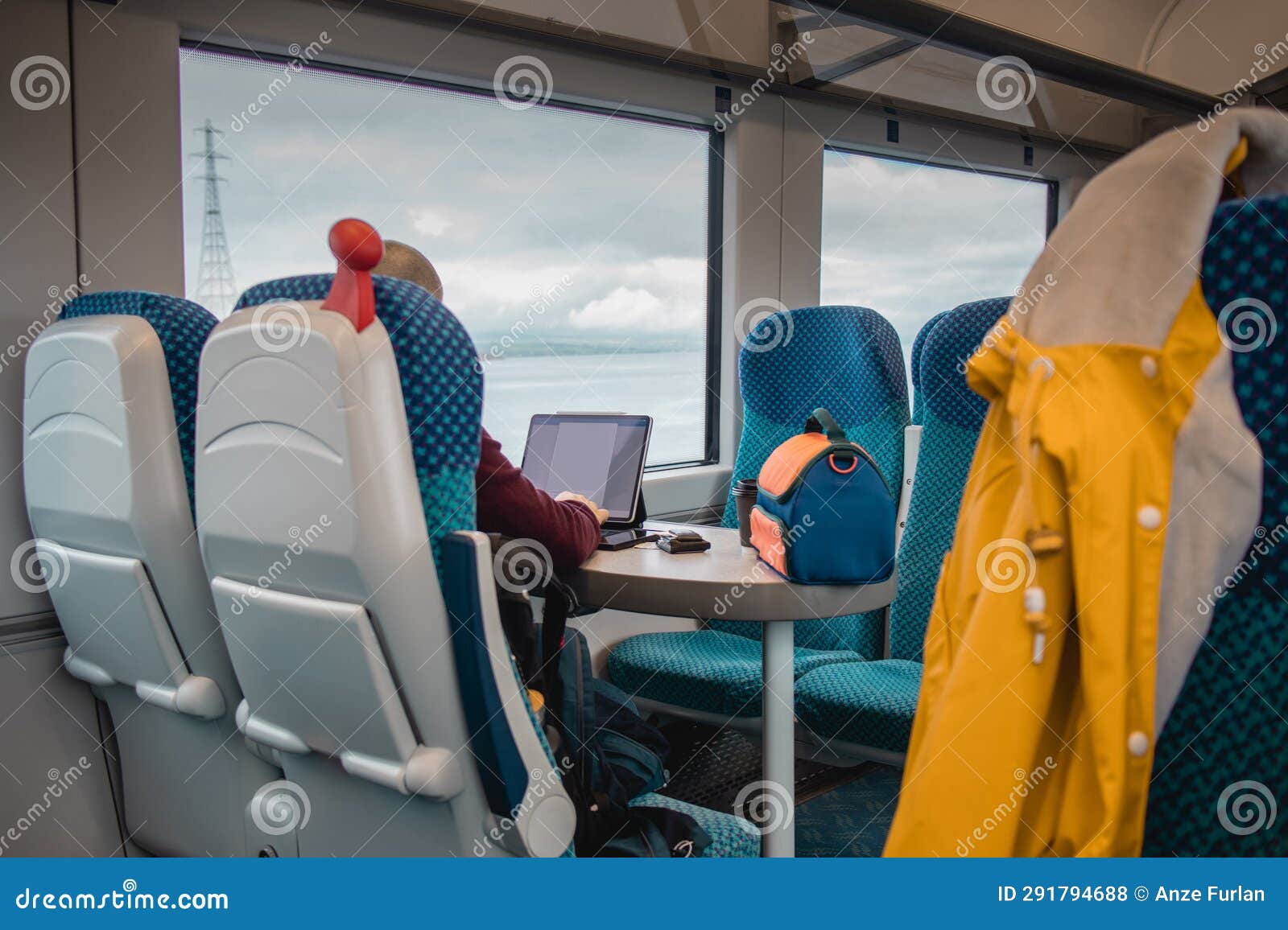 Person Working on a Laptop Computer while Commuting with a Train ...
