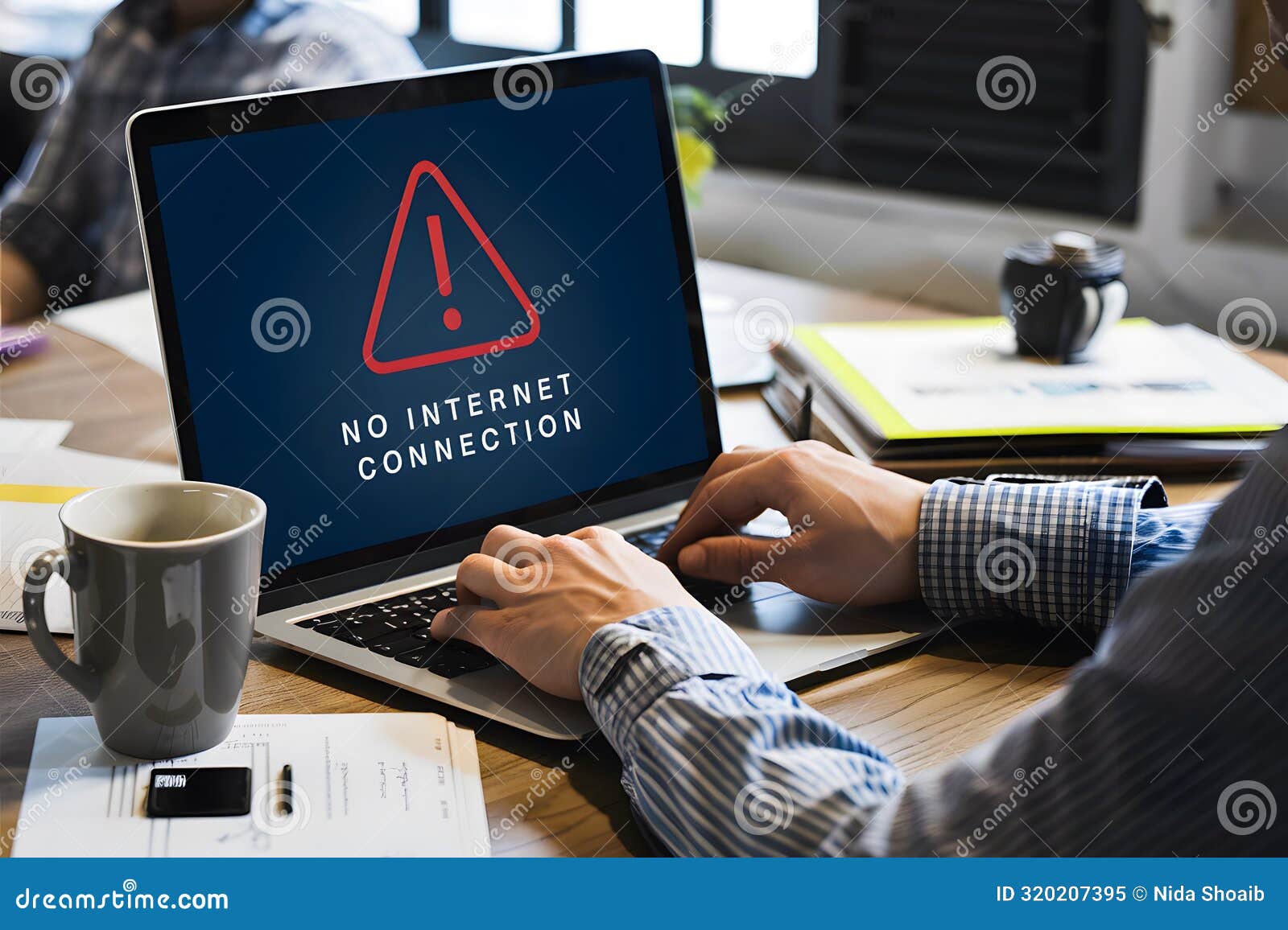 Person Working on Laptop with No Internet Connection Warning, Red ...