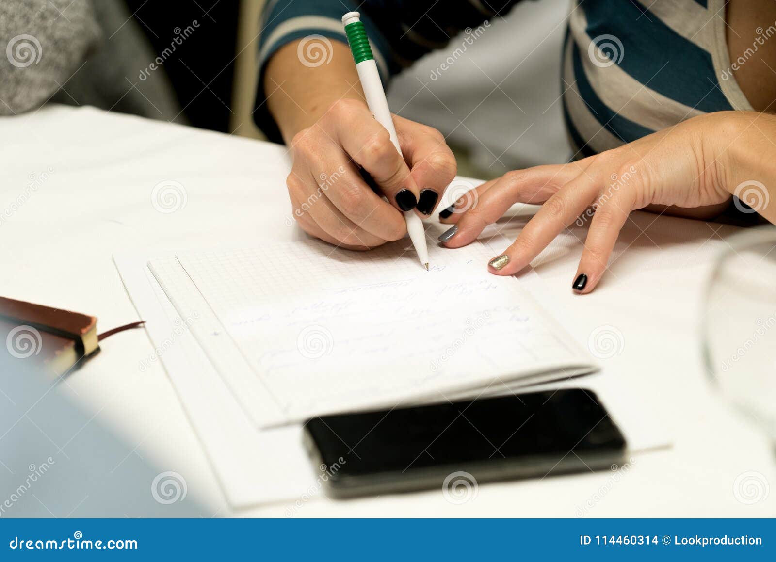 Person writing in notepad stock photo. Image of study - 114460314