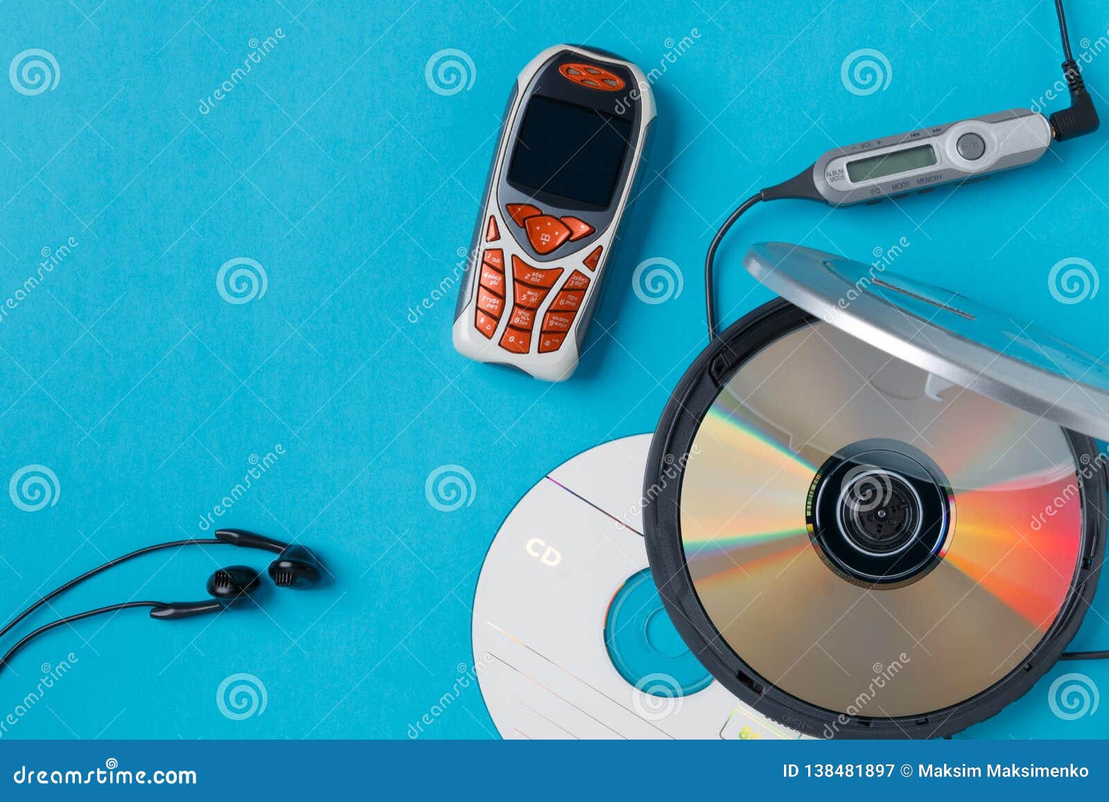 Personal Cd Player with Remote Control and Mobile Phone on Blue ...