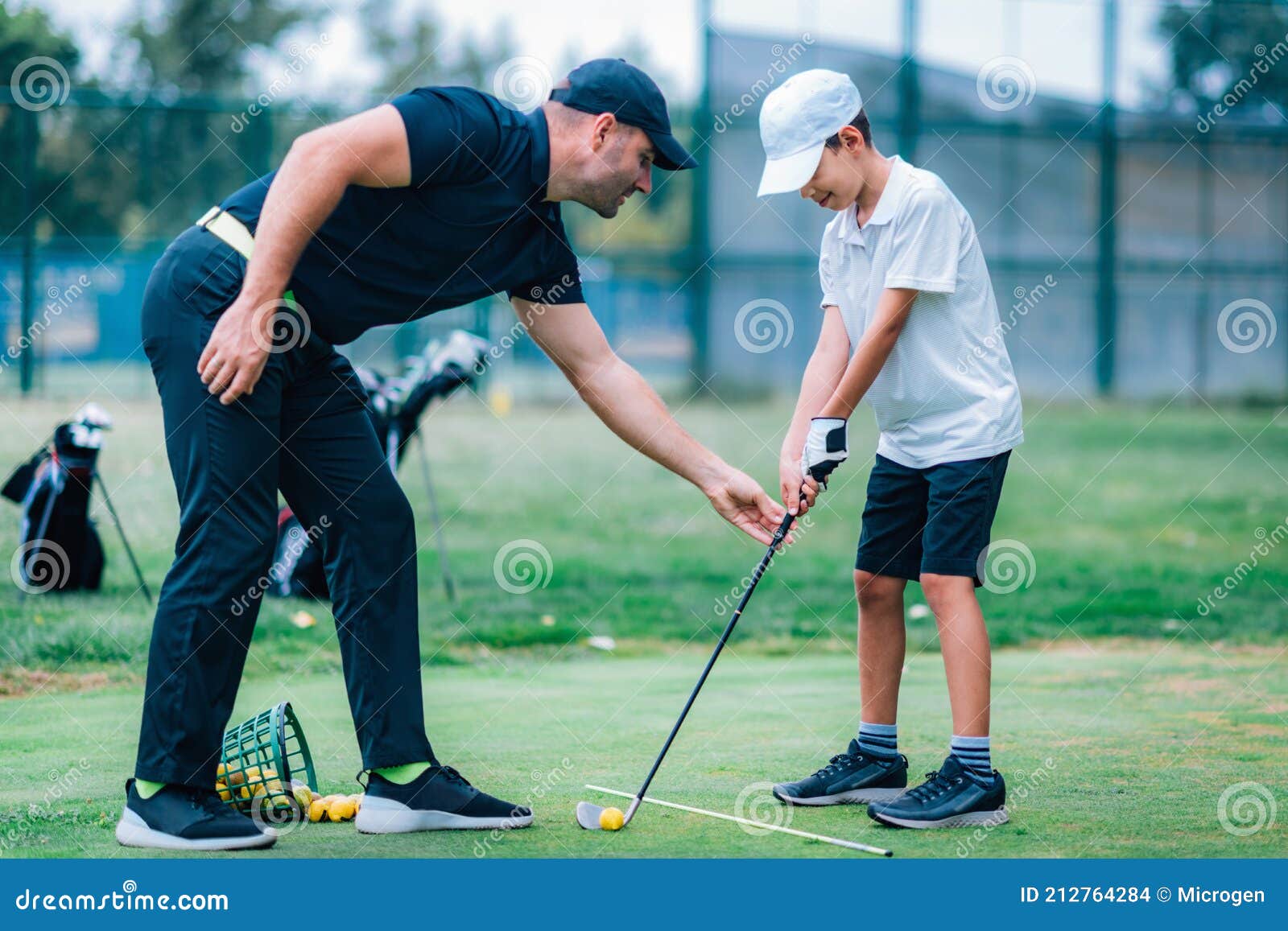 Personal Golf Lesson. Golf Instructor with Young Boy on a Golf Driving ...