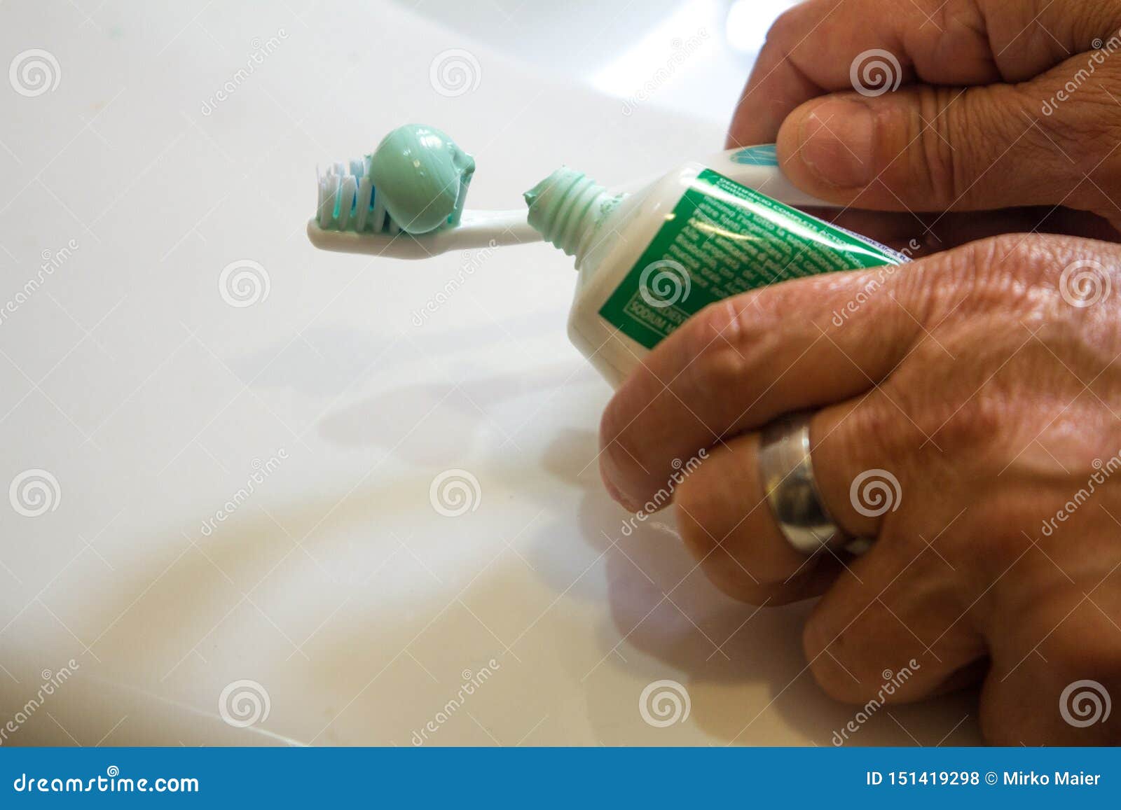 Personal Hygiene with Hands Squeezing Toothpaste on the Toothbrush ...