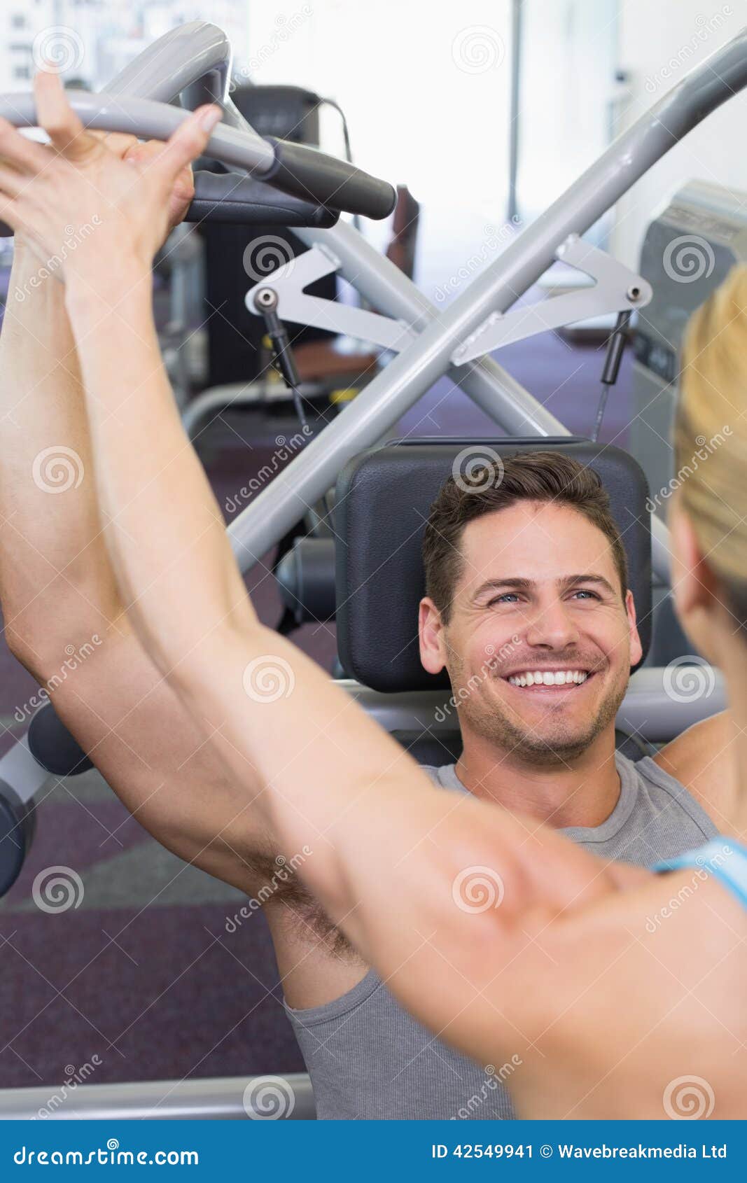 Personal Trainer Coaching Bodybuilder Using Weight Machine Stock Image ...