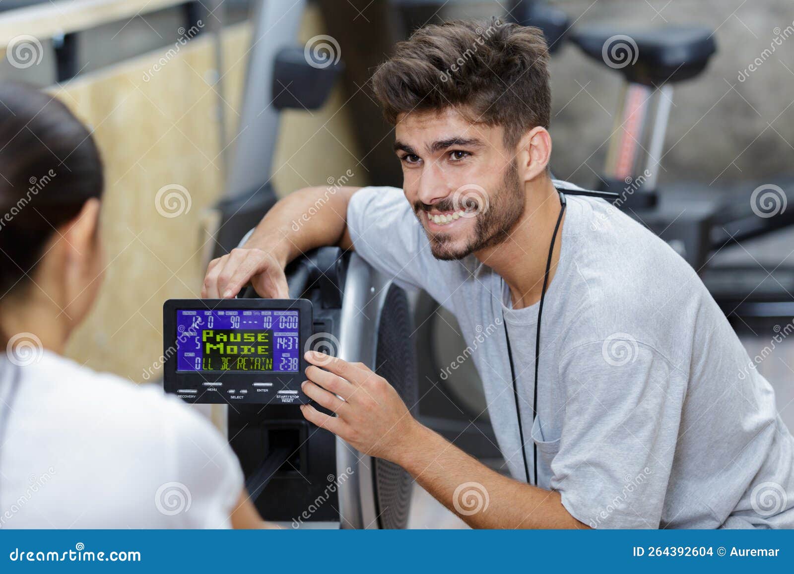 Personal Trainer Explaining Digital Controls on Exercise Machine Stock ...