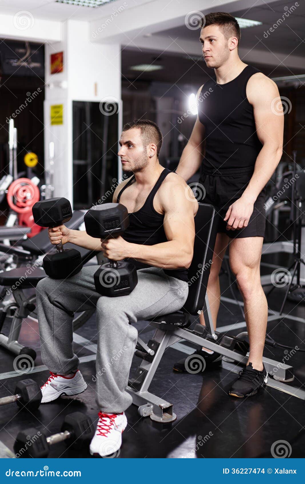 Personal Trainer Helping Athletic Man Stock Photo - Image of lifting ...