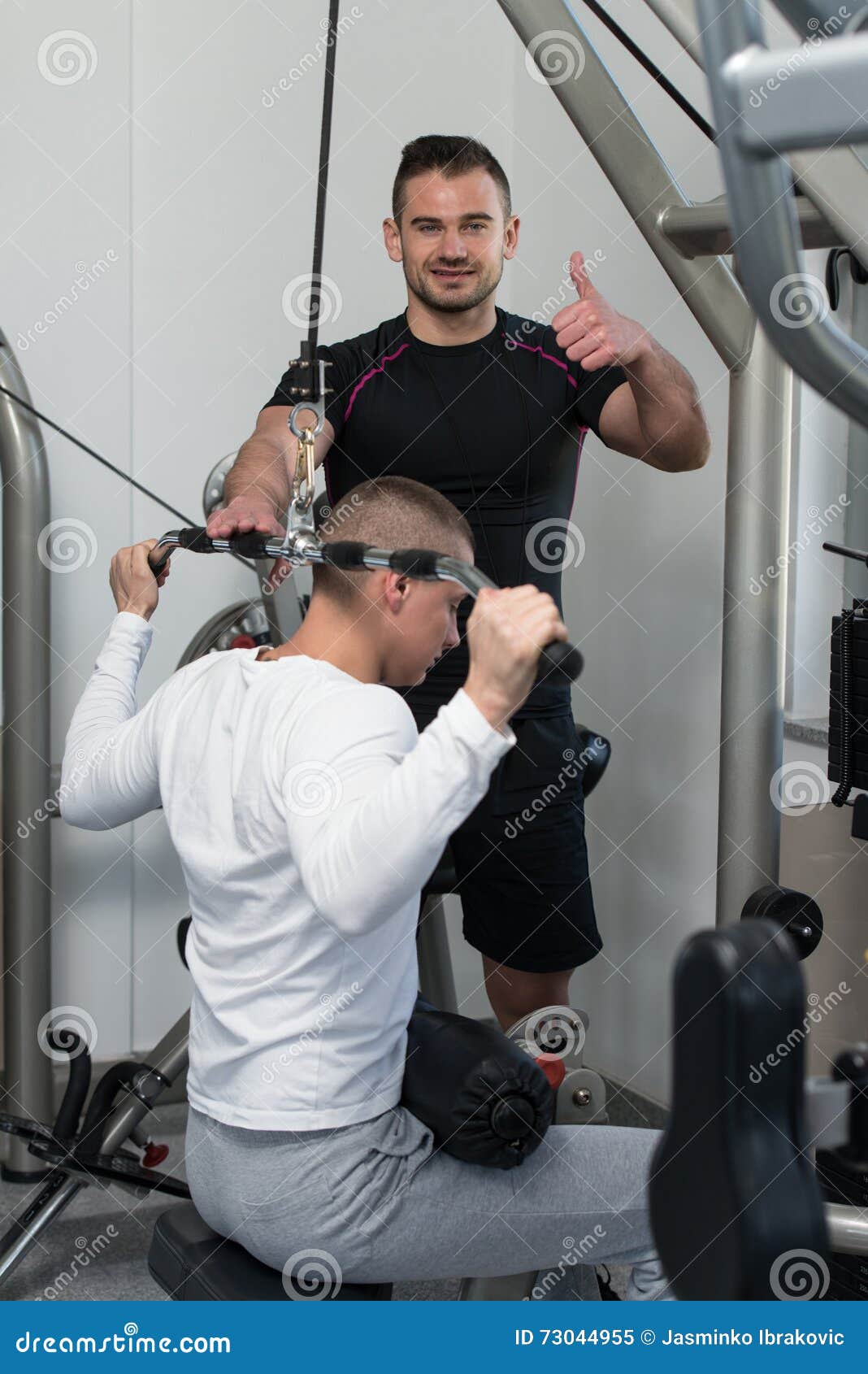 Personal Trainer Helping Client in Gym Stock Image - Image of body ...