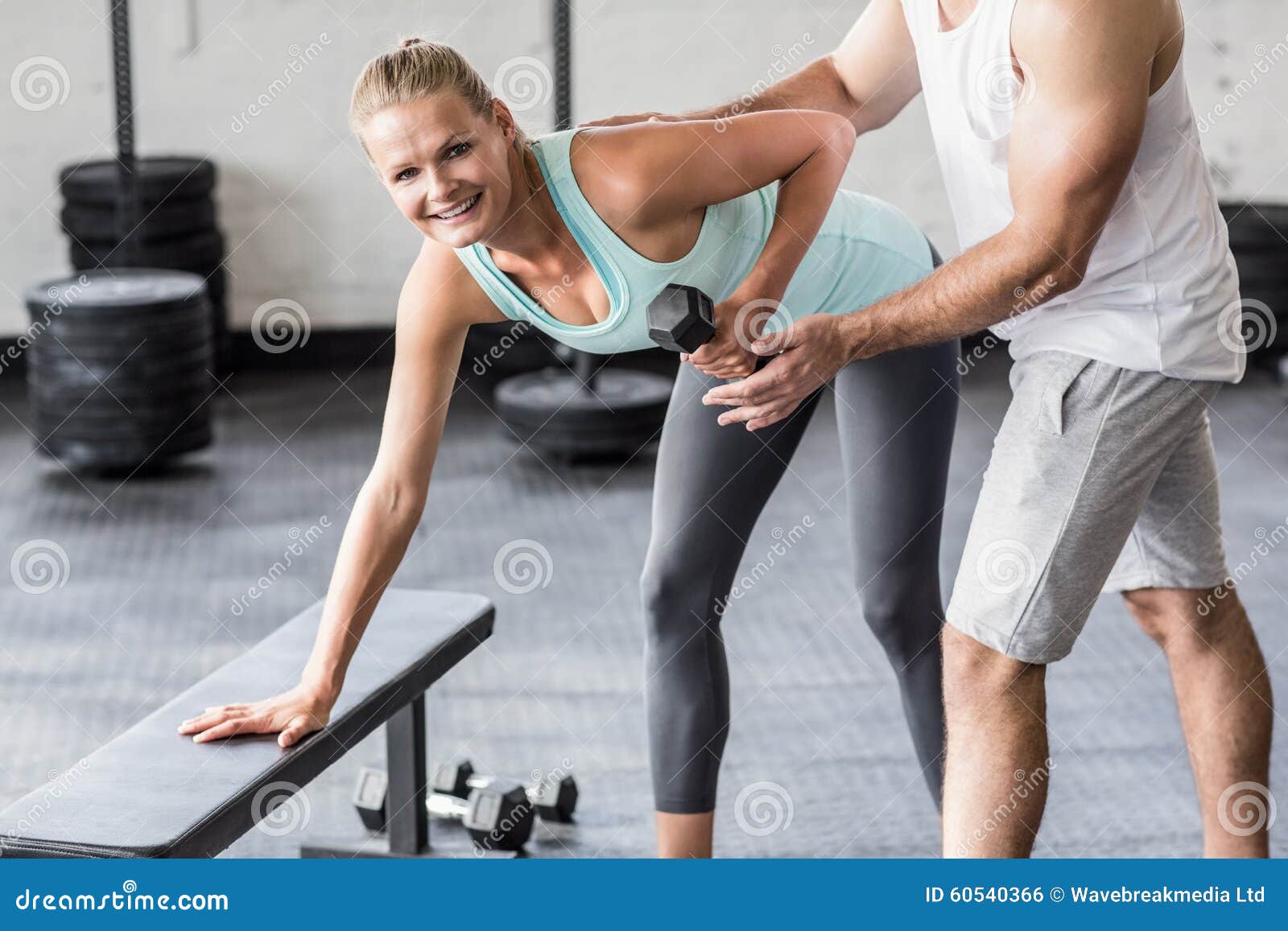 Personal Trainer Helping Client Lift Dumbbells Stock Photo - Image of ...