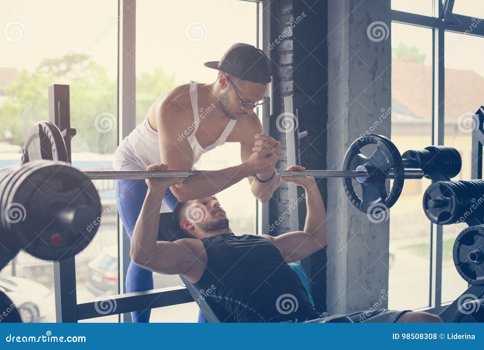Personal Trainer Helping Man in the Gym. Stock Photo - Image of hands ...