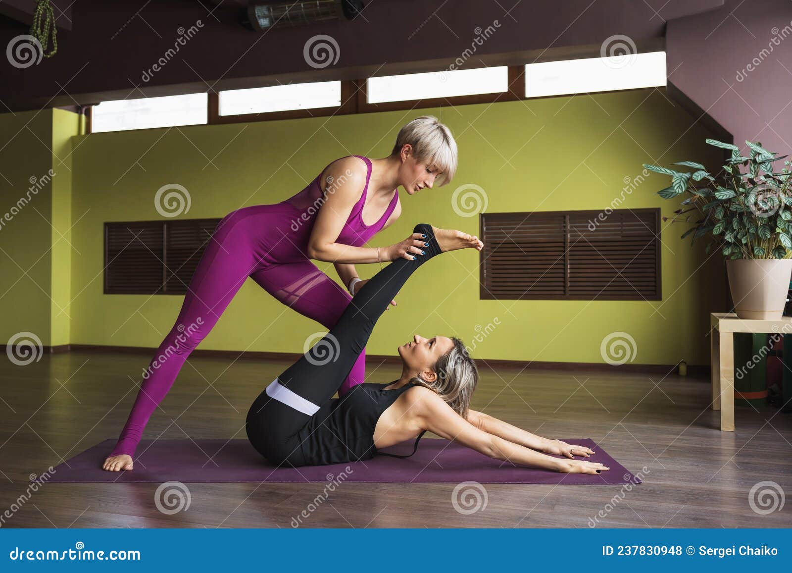The Personal Trainer Helps the Student Perform an Exercise To Stretch ...