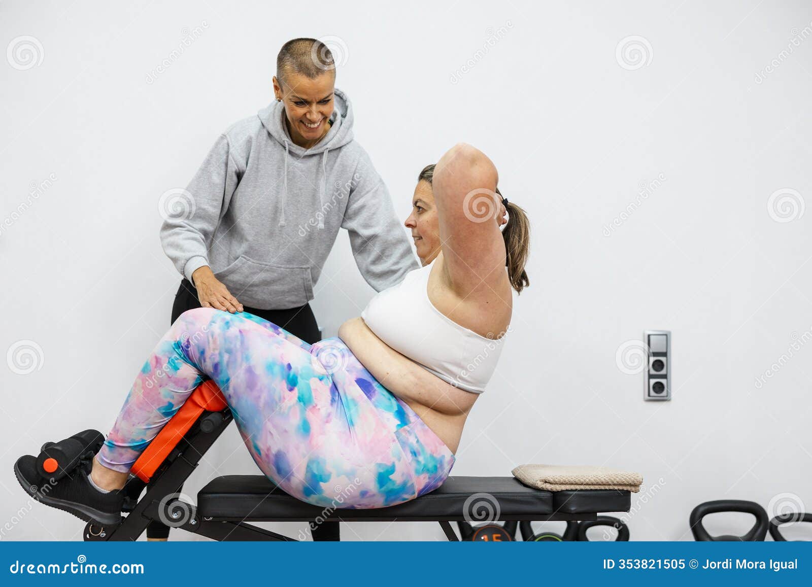 Personal Trainer Supporting Overweight Client Doing Sit Ups on Bench ...