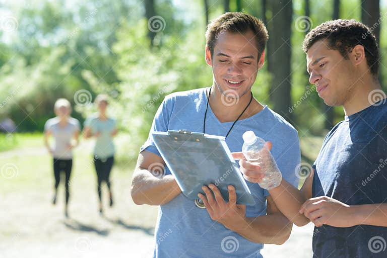 Personal Trainer Takes Notes after Exercising Outdoors Stock Photo ...