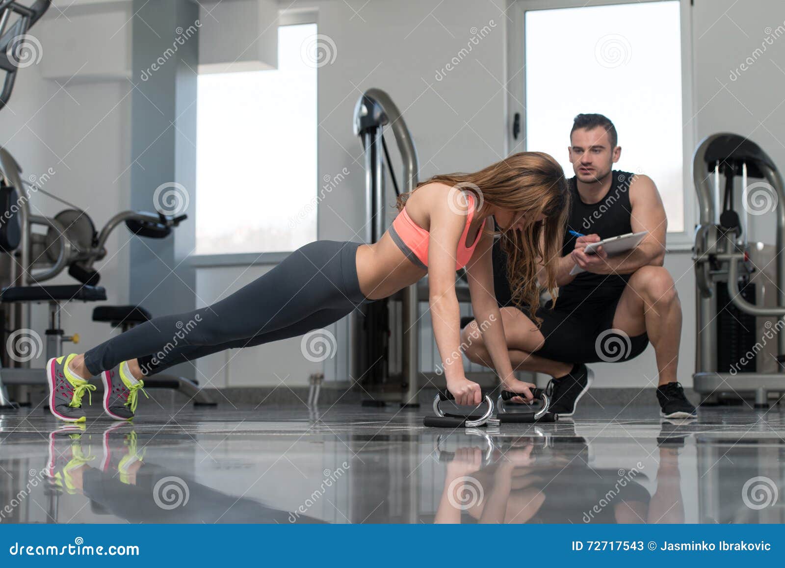 Personal Trainer Takes Notes while Woman Doing Push-Up Stock Image ...