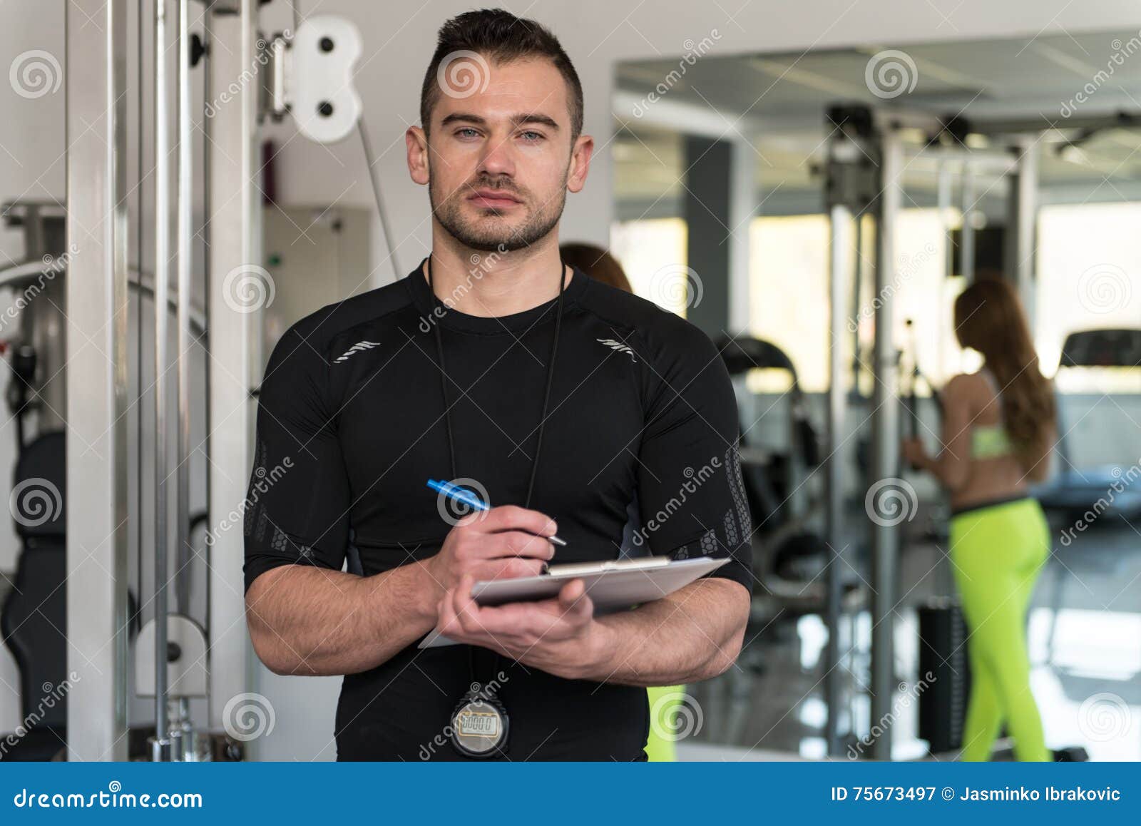 Personal Trainer Takes Notes while Woman Exercising Biceps Stock Image ...