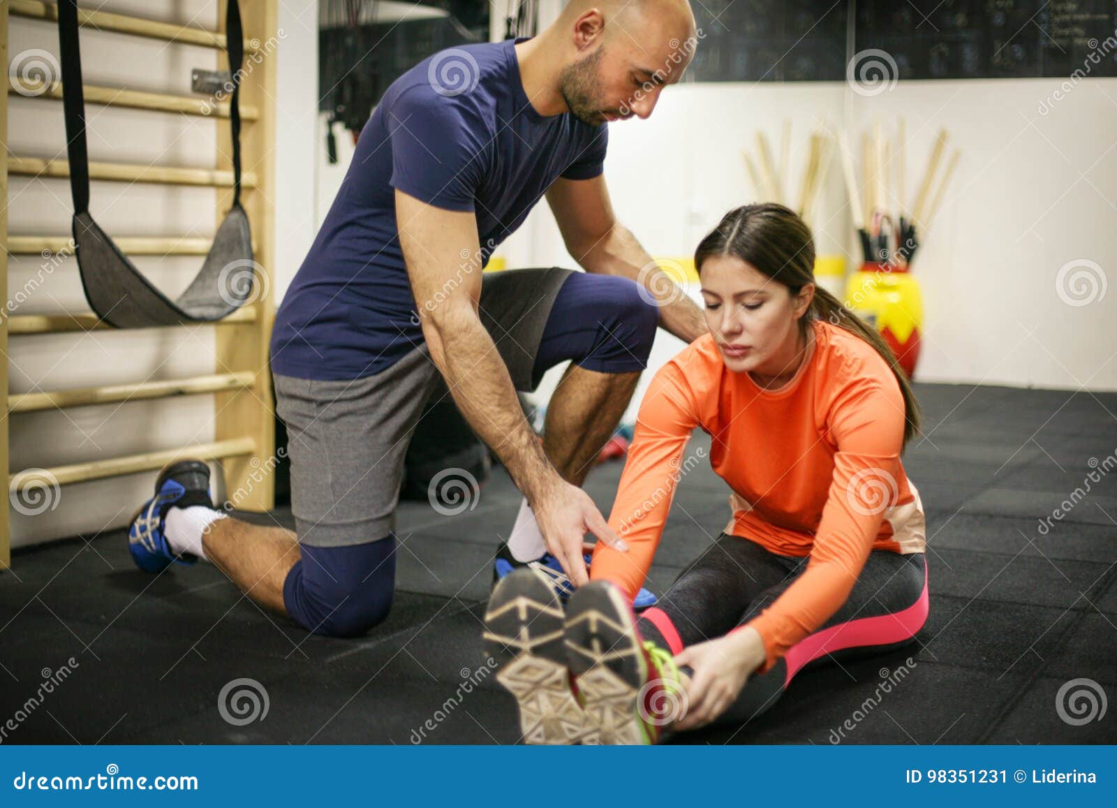 Personal Trainer Training His Client in the Gym. Stock Image - Image of ...