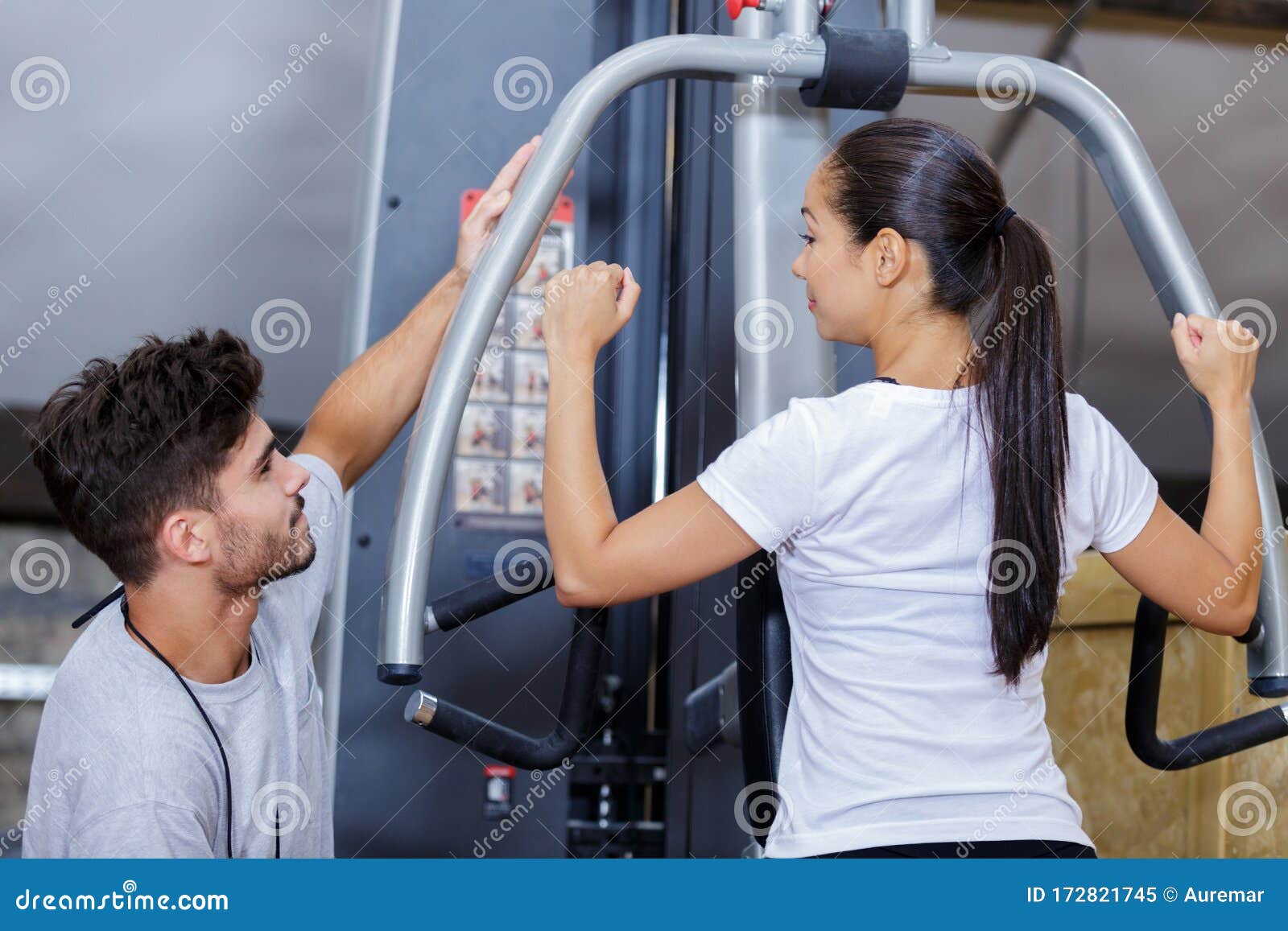 Personal Trainer Watching Woman Using Gym Equipment Stock Image - Image ...