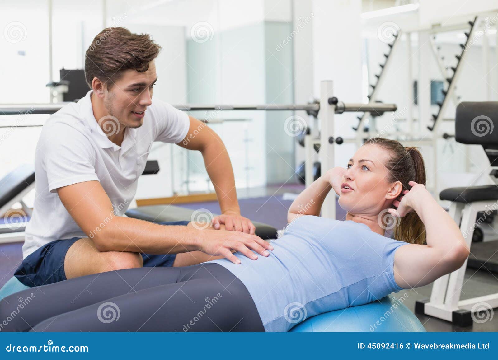 Personal Trainer Working with Client on Exercise Ball Stock Photo ...