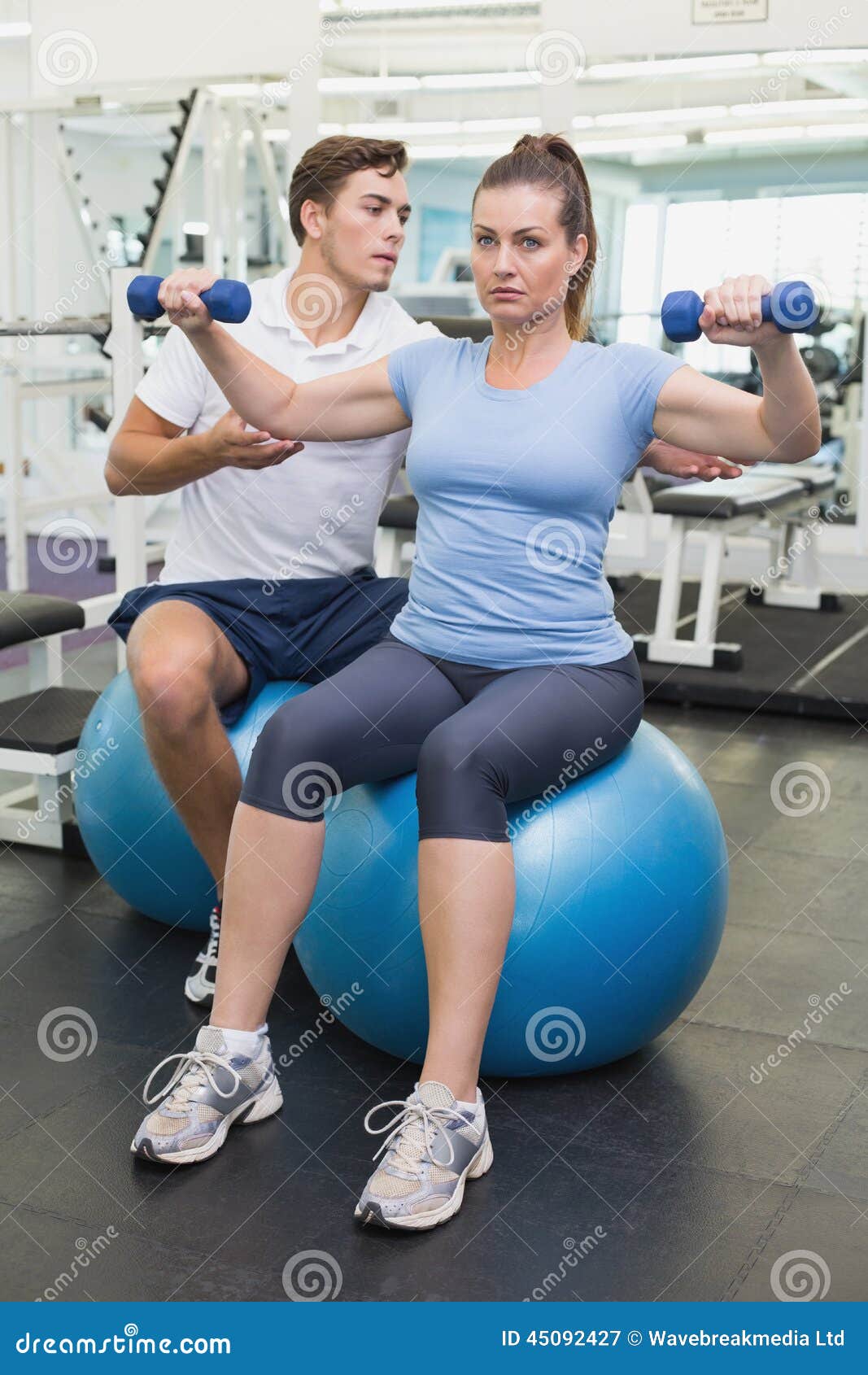 Personal Trainer Working with Client on Exercise Ball Stock Image ...