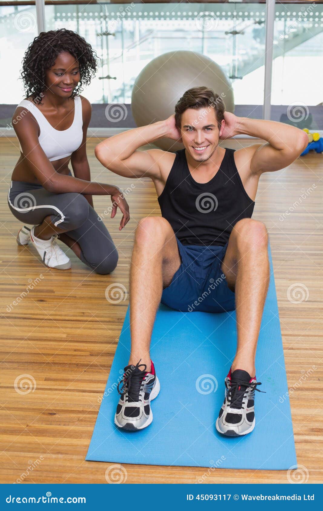 Personal Trainer Working with Client on Exercise Mat Stock Image ...
