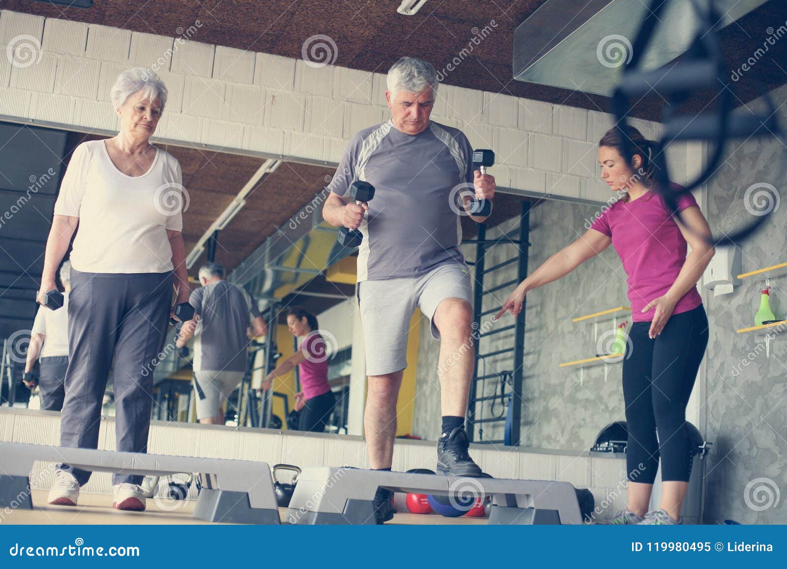 Personal Trainer Working Exercise with Senior Couple. Stock Image ...