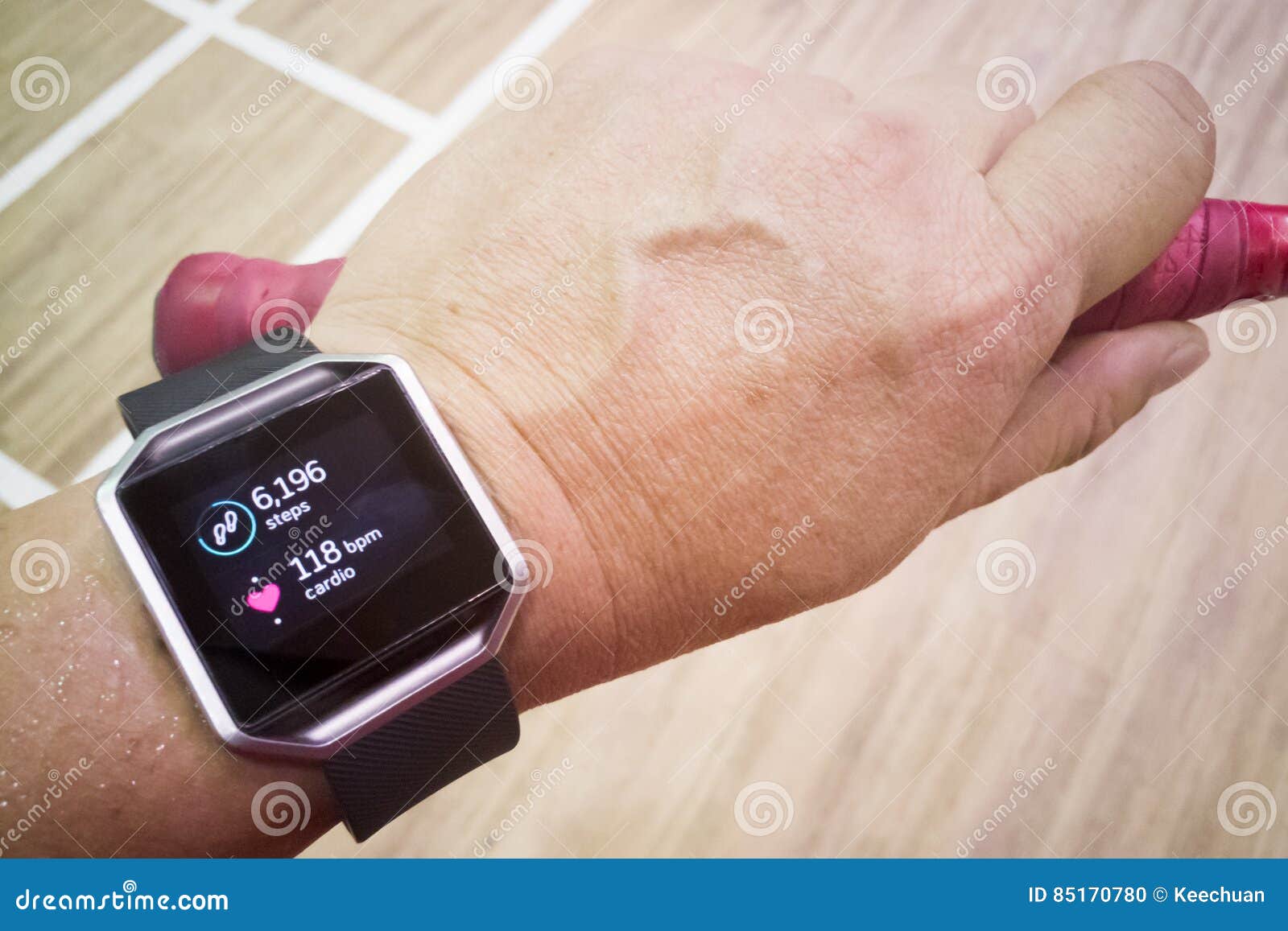 Perspective View Person Reading Watch with Steps and Heart Tracker ...