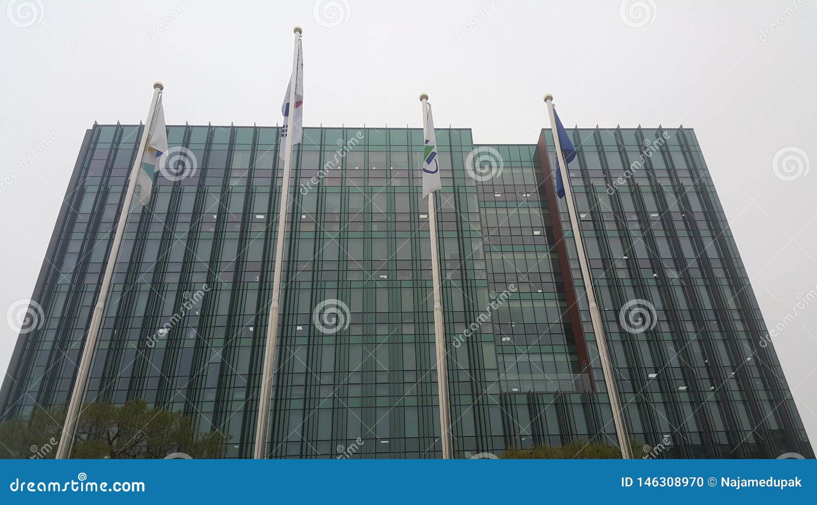 Perspective View of a Skyscraper Building with Flags in Front of it ...