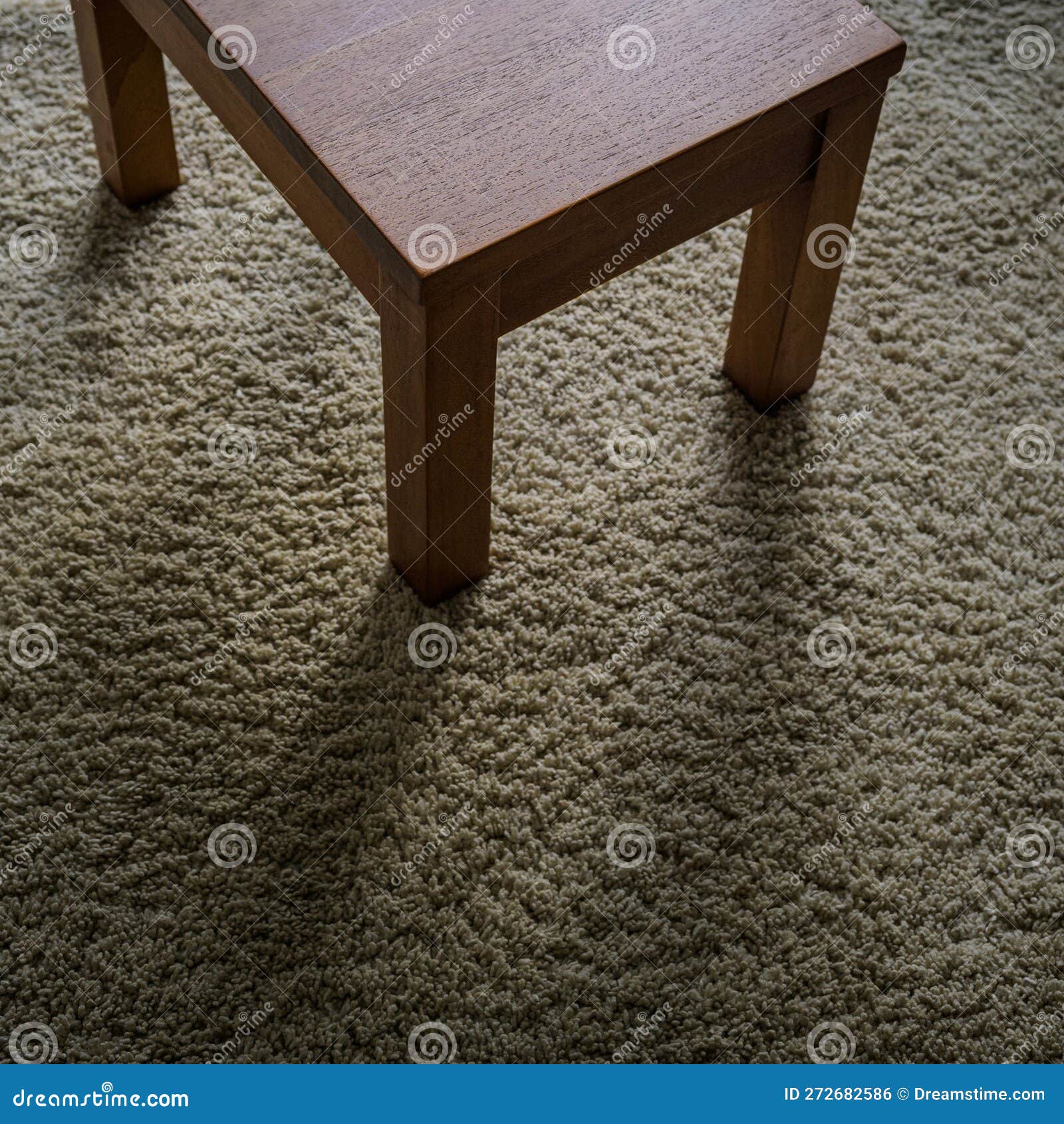 Perspective View of Small Teak Table on Beige Carpet. Stock Photo ...
