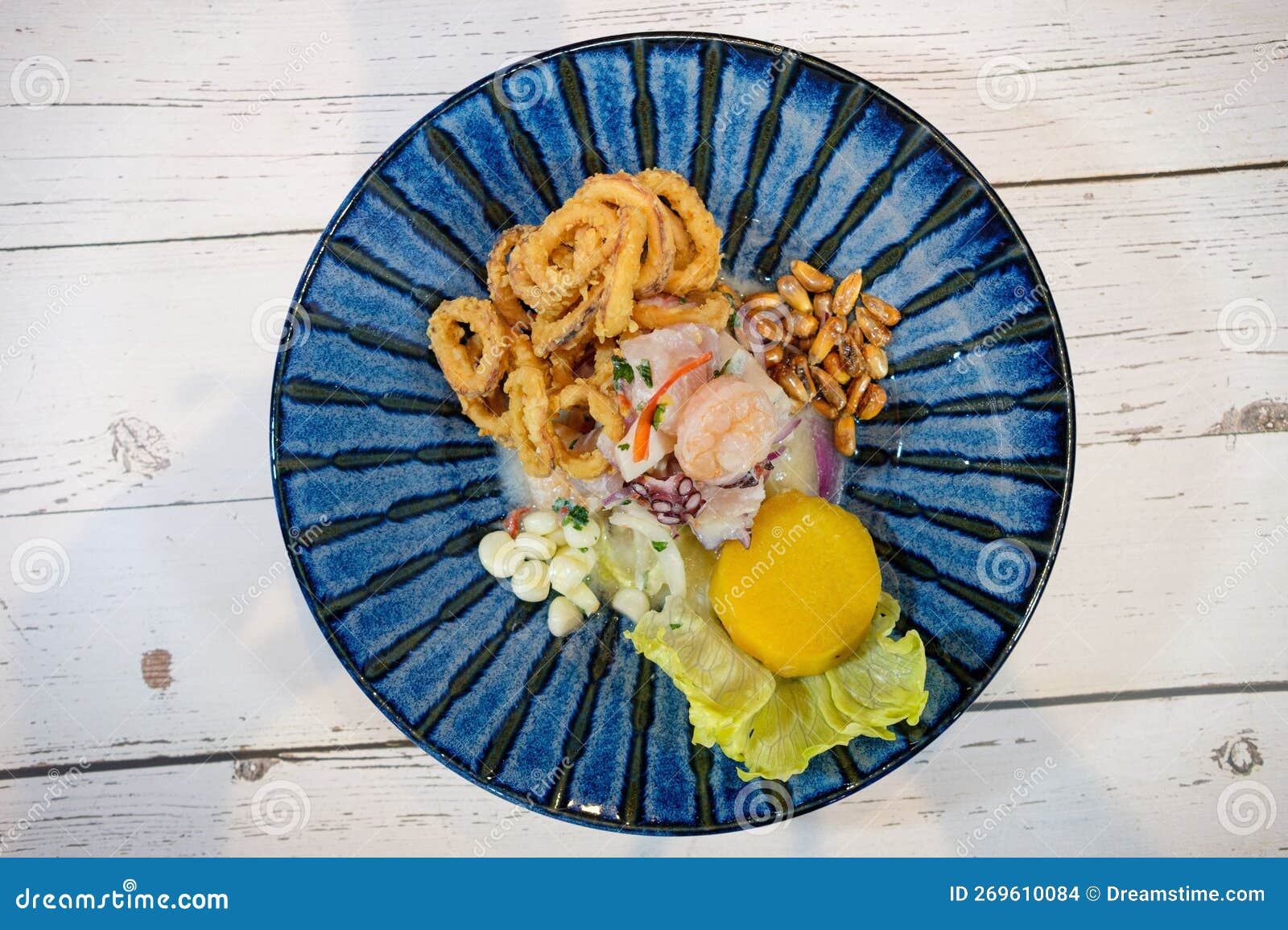 Peruvian Ceviche Served on a Blue Colored Plate, on a White Wooden ...