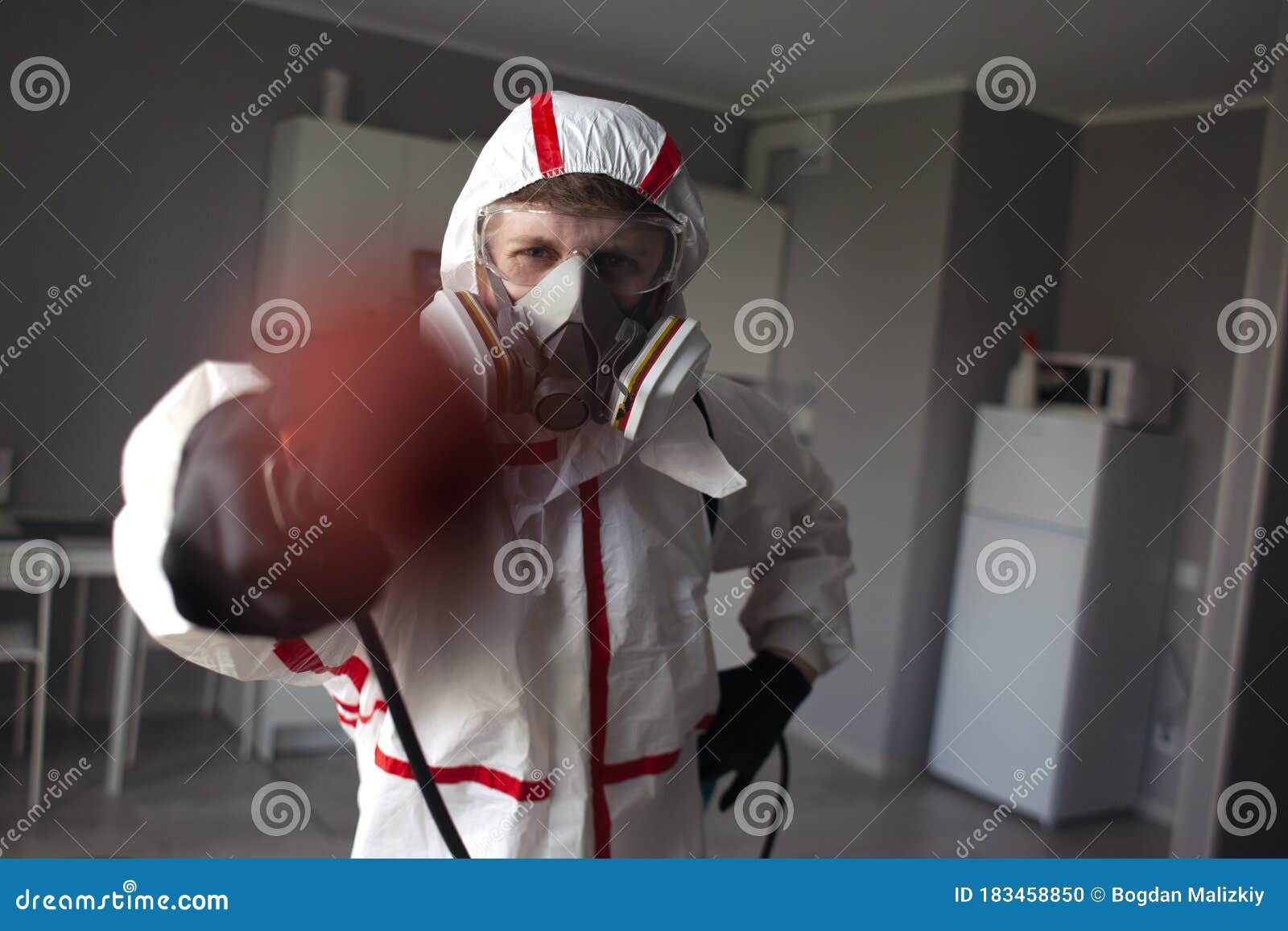 Pest Control. a Worker in a Protective Suit is Cleaning a Room with a ...