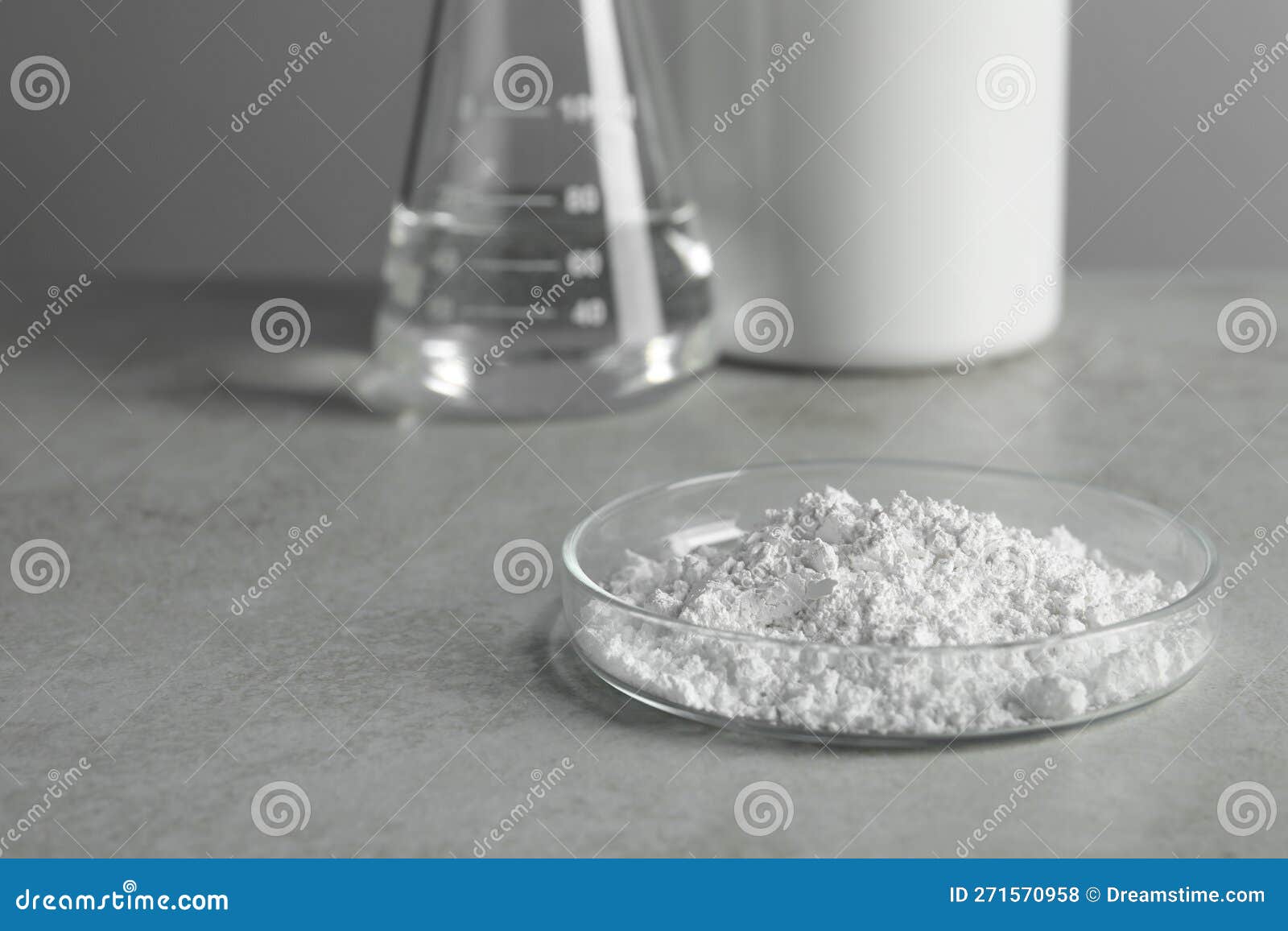 Petri Dish with Calcium Carbonate Powder on Light Grey Table. Space for ...