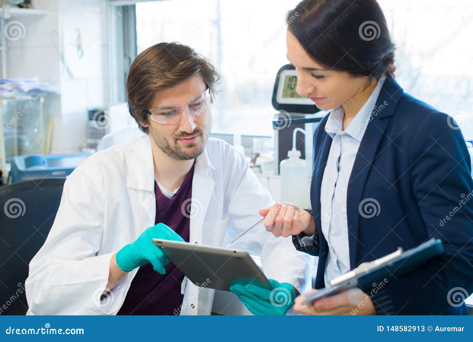 Pharmaceutical Scientist Looking at Information on Tablet Stock Image ...