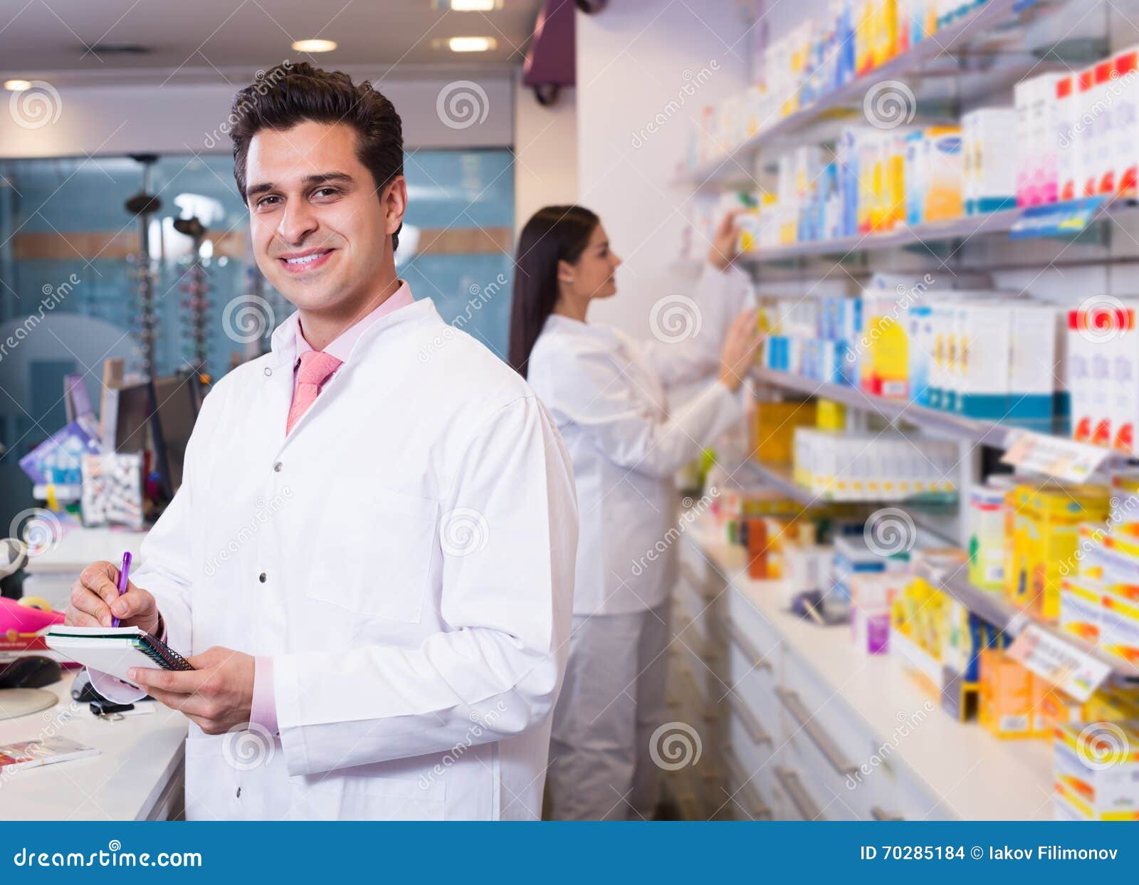 Pharmaceutists at Reception of Drugstore Ready To Help Stock Photo ...