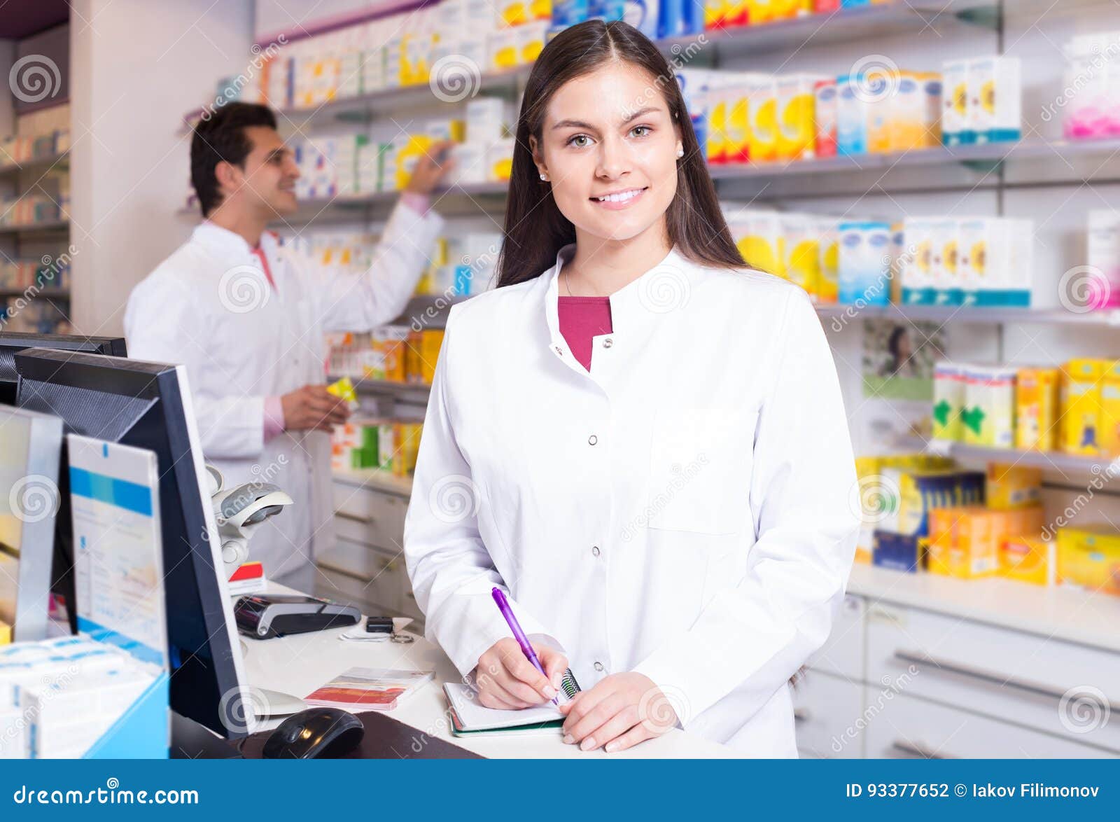 Pharmaceutists at Reception of Drugstore Ready To Help Stock Photo ...