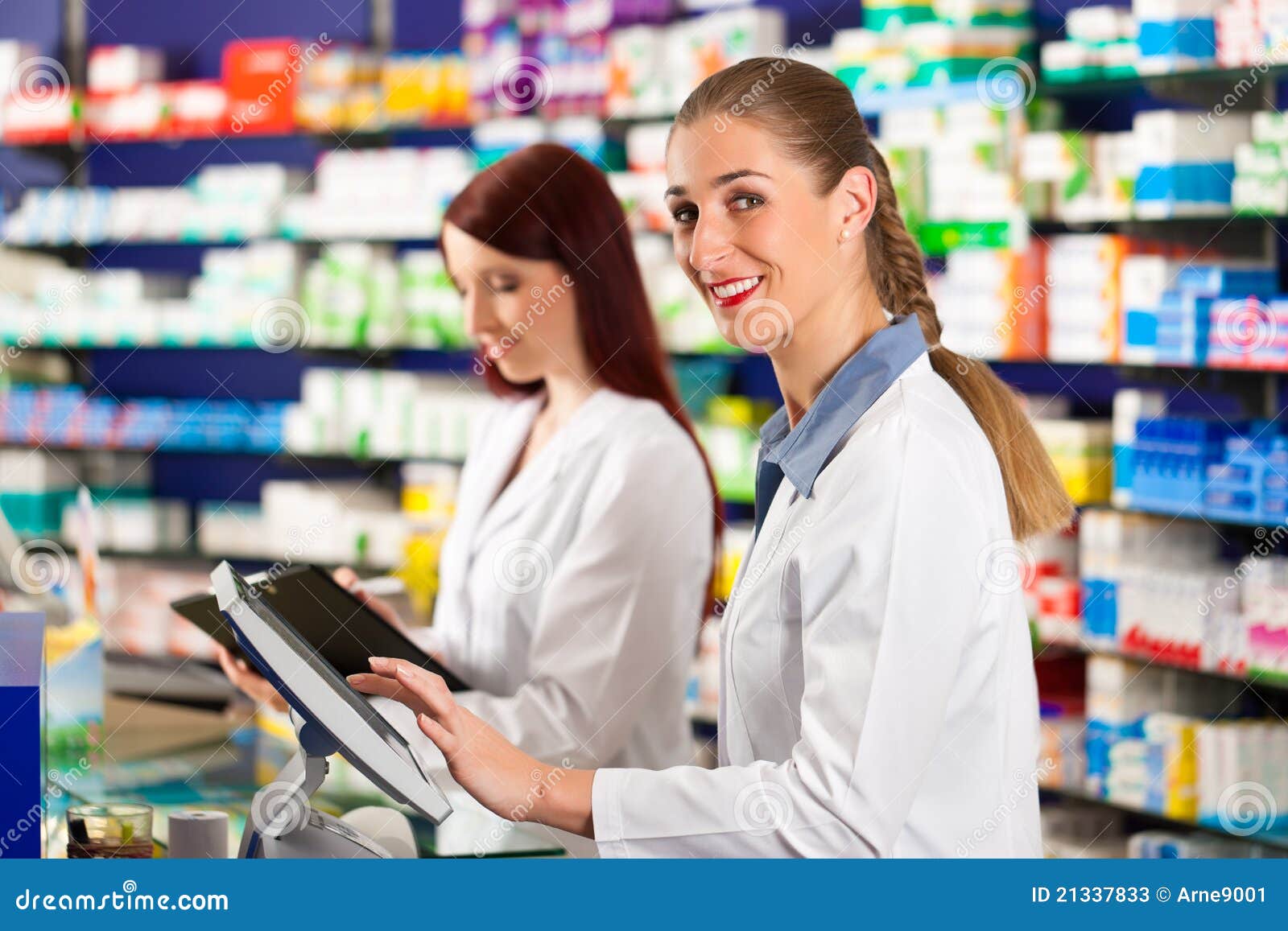 Pharmacist with Assistant in Pharmacy Stock Image - Image of people ...
