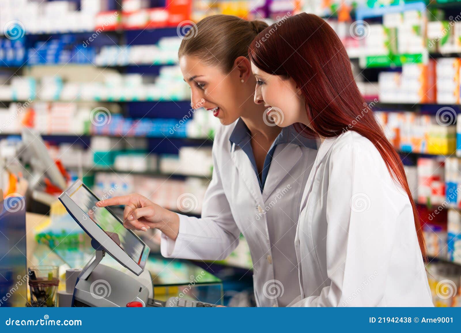 Pharmacist with Assistant in Pharmacy Stock Photo - Image of products ...