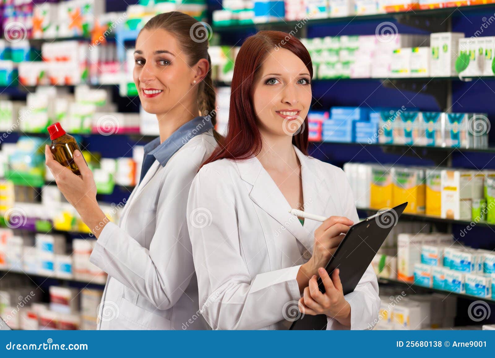 Pharmacist with Assistant in Pharmacy Stock Photo - Image of drugs ...