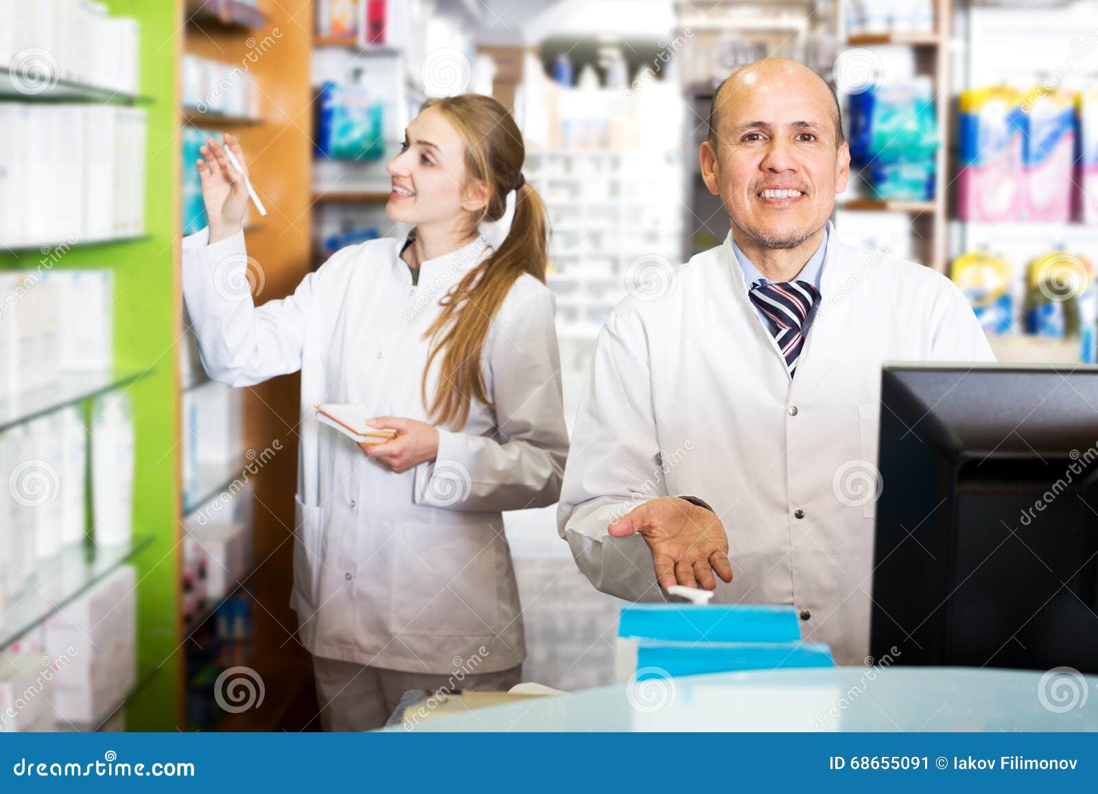 Pharmacist and Assistant Working at Farmacy Reception Stock Image ...