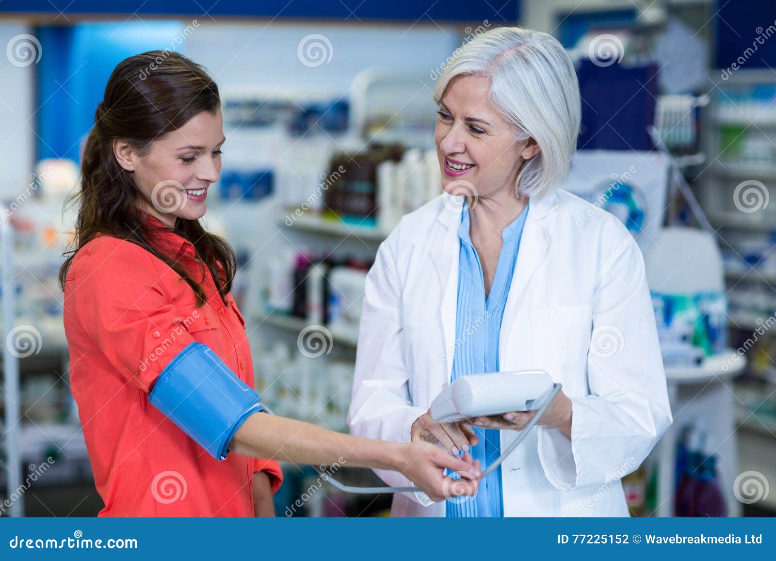 Pharmacist Checking Blood Pressure of Customer Stock Photo - Image of ...
