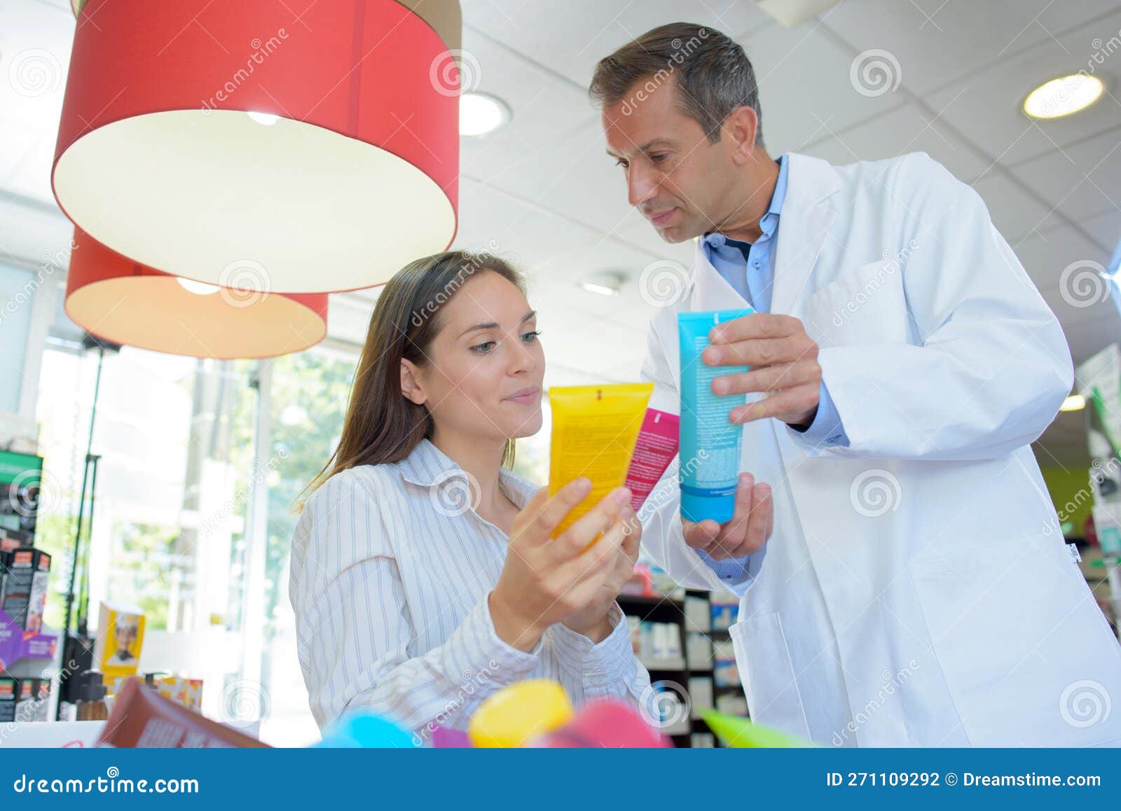 Pharmacist Comparing Products with Customer Stock Photo - Image of ...
