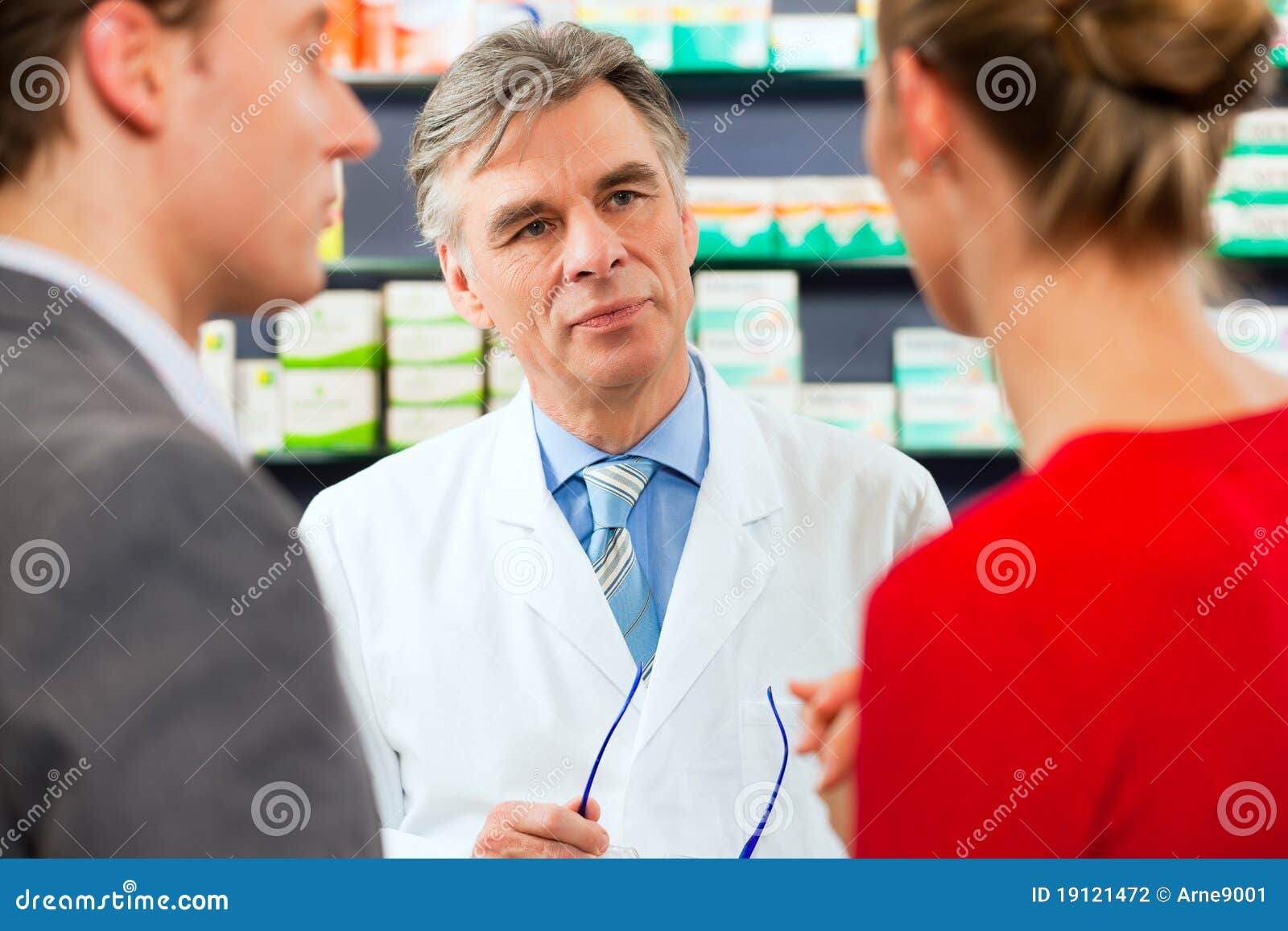 Pharmacist with Customers in Pharmacy Stock Photo - Image of ...