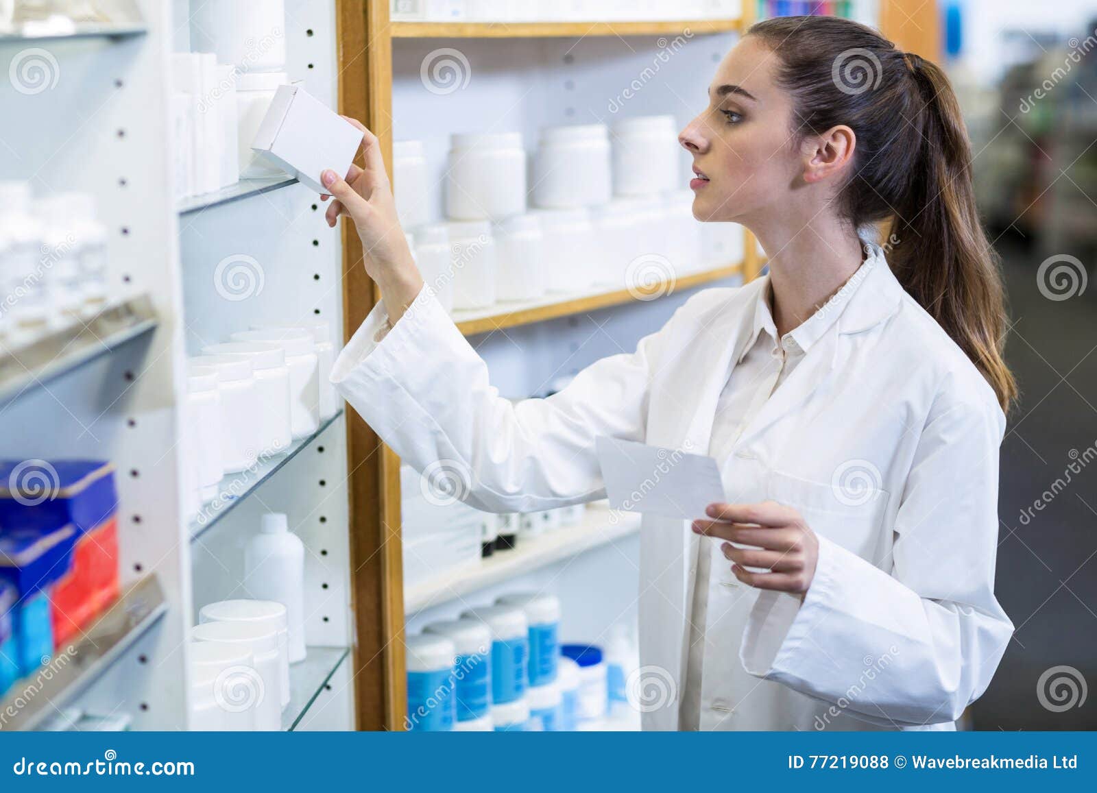 Pharmacist Holding Prescription while Checking Medicine Stock Photo ...