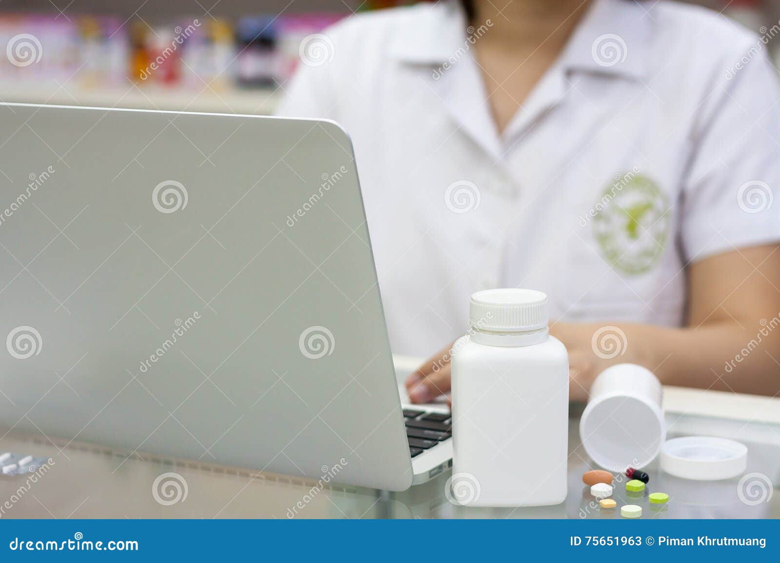 Pharmacist with Laptop Computer and Medication in the Pharmacy Stock ...