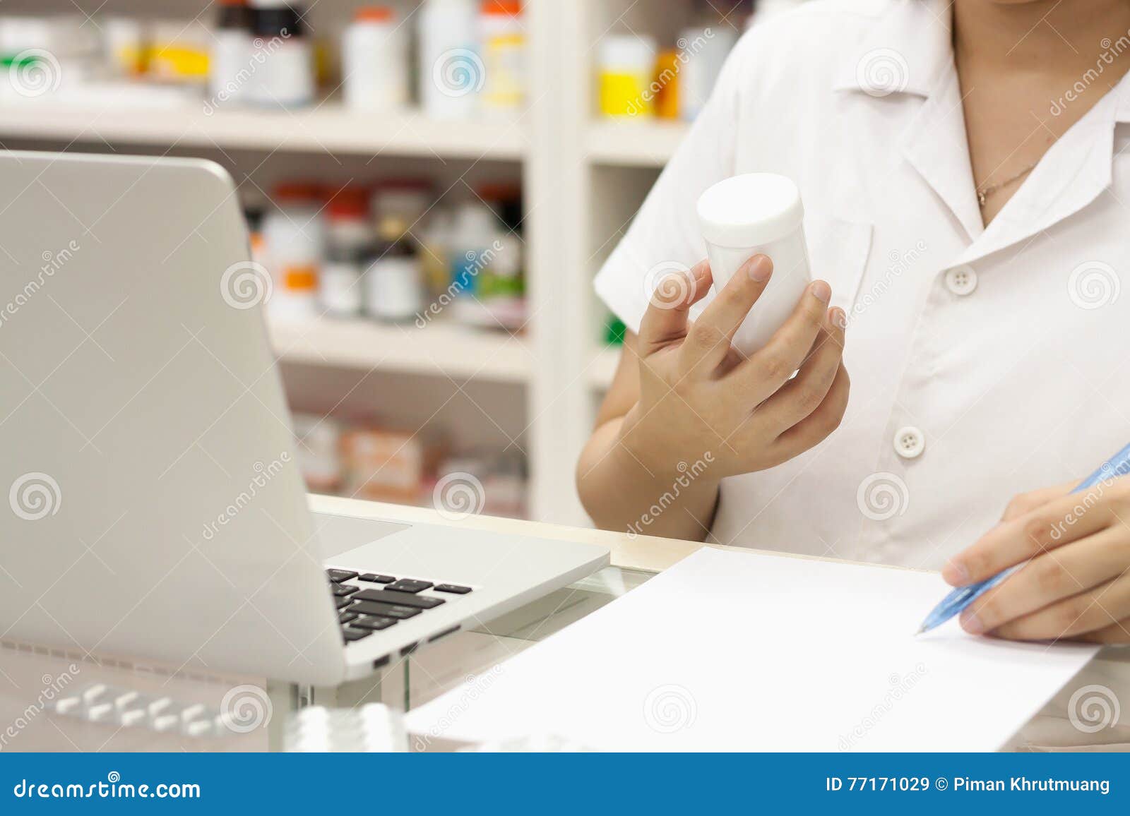 Pharmacist with Laptop Computer and Medication in the Pharmacy Stock ...