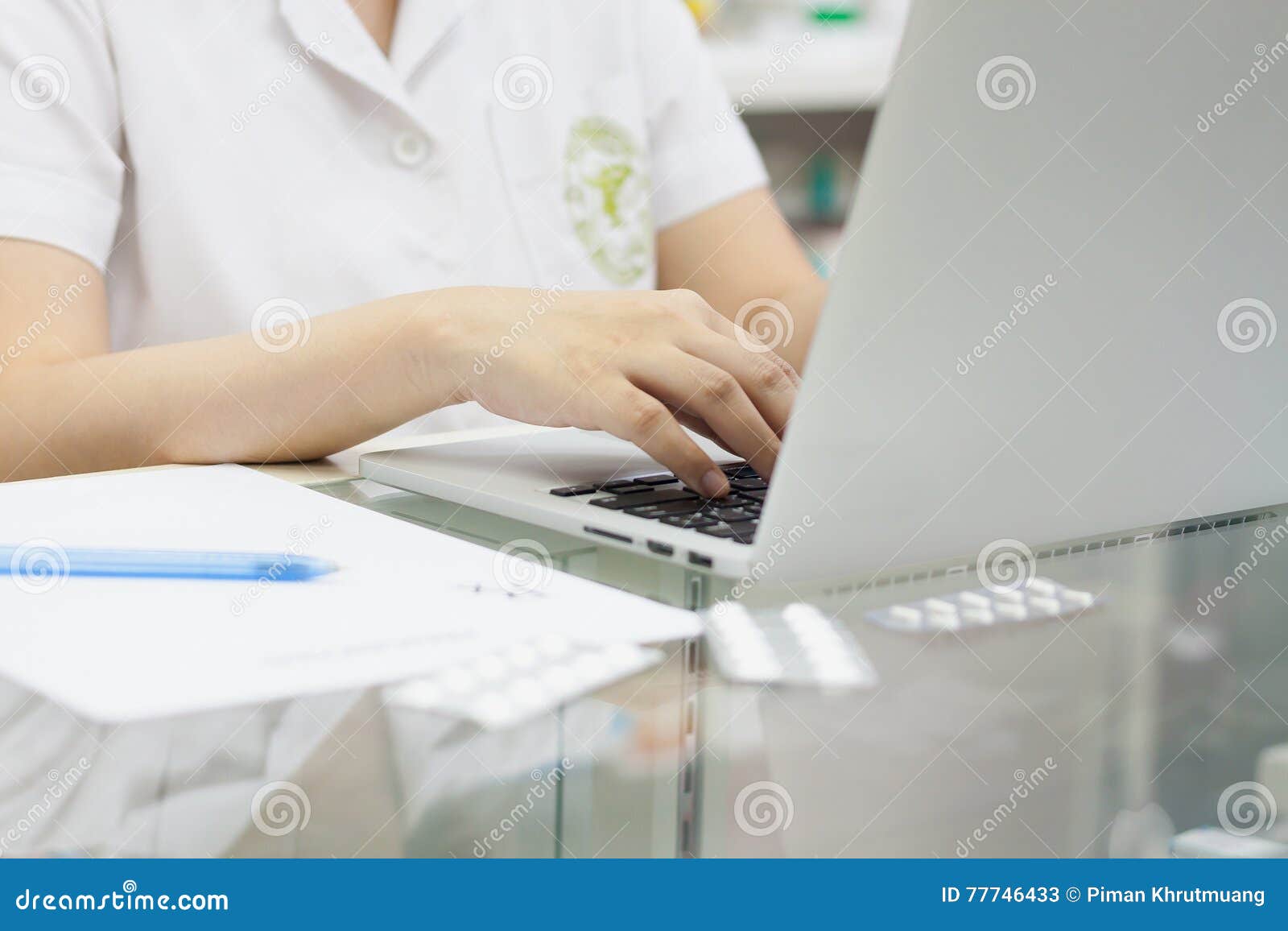 Pharmacist with Laptop Computer and Medication in the Pharmacy Stock ...