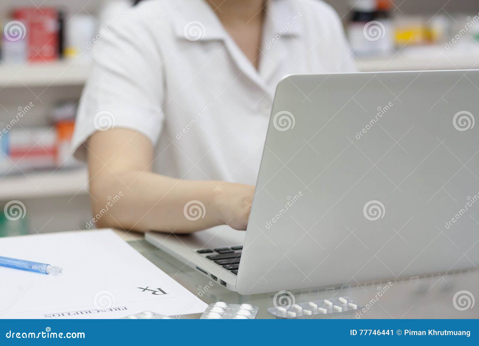 Pharmacist with Laptop Computer and Medication in the Pharmacy Stock ...
