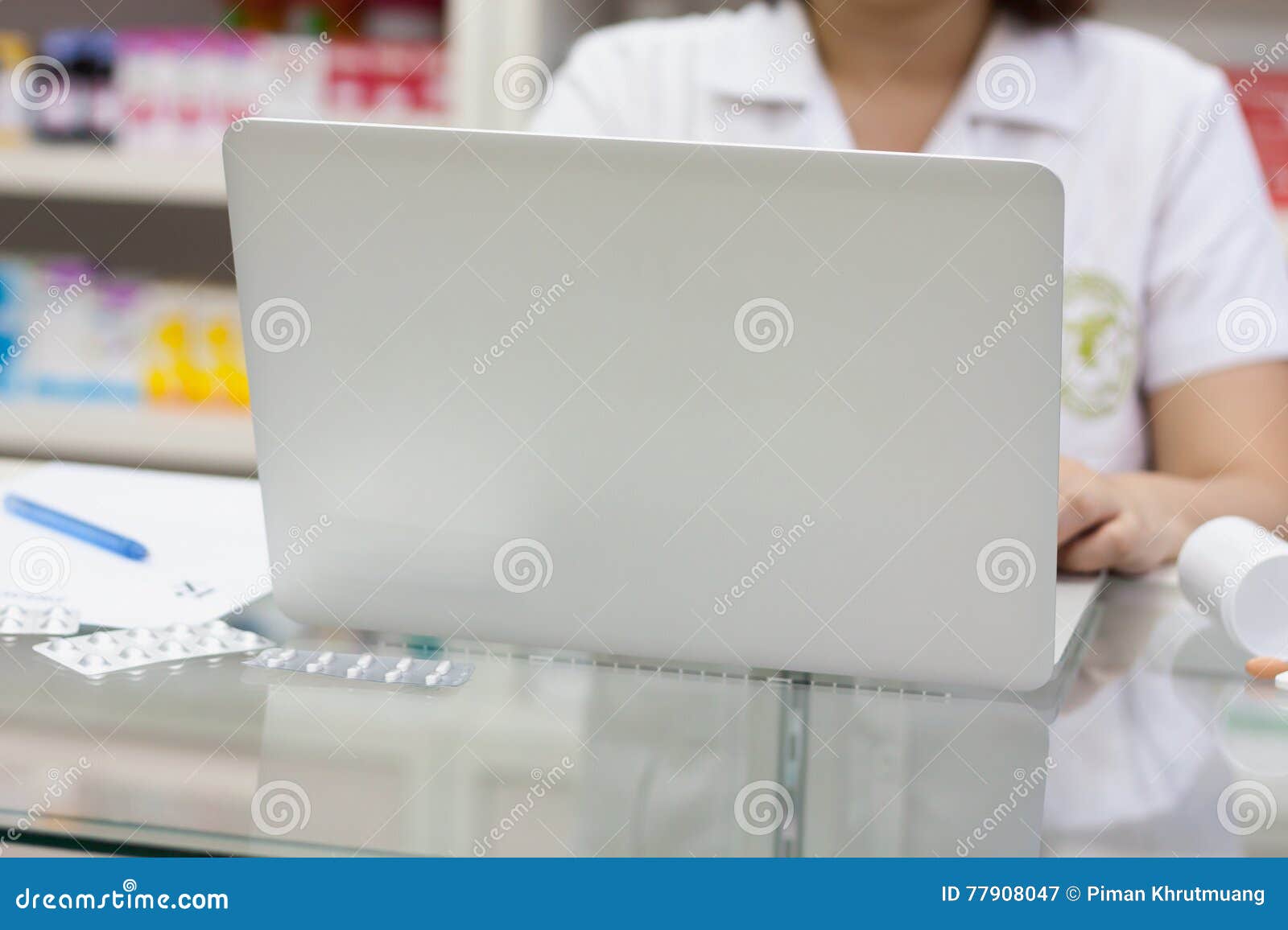 Pharmacist with Laptop Computer and Medication in the Pharmacy Stock ...