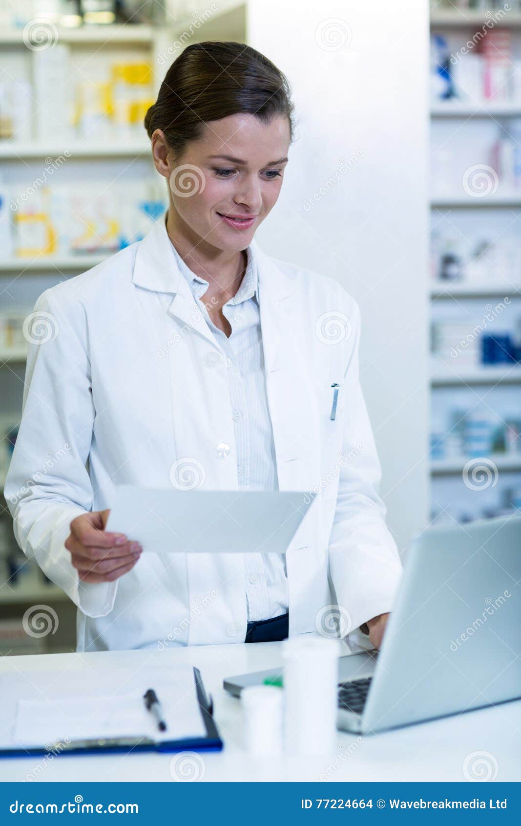 Pharmacist Making Prescription Record in Laptop Stock Photo - Image of ...