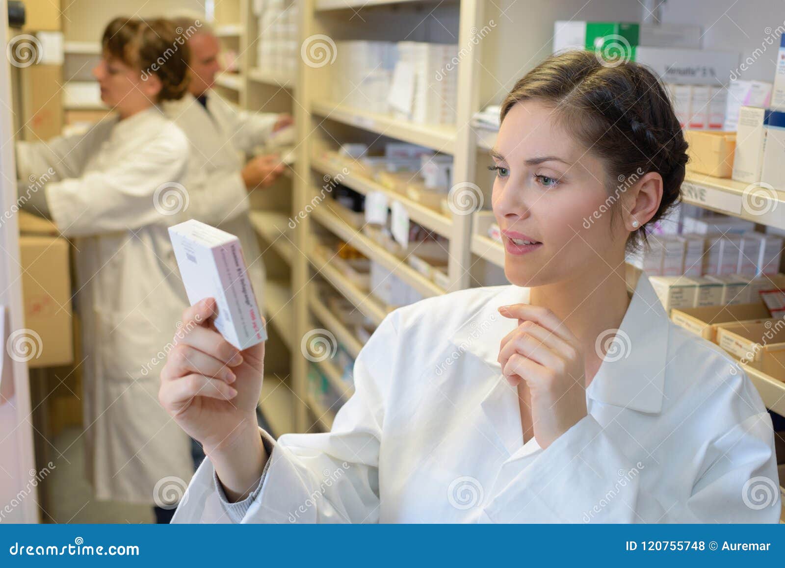 Pharmacist Reading Information on Packet Stock Photo - Image of coat ...
